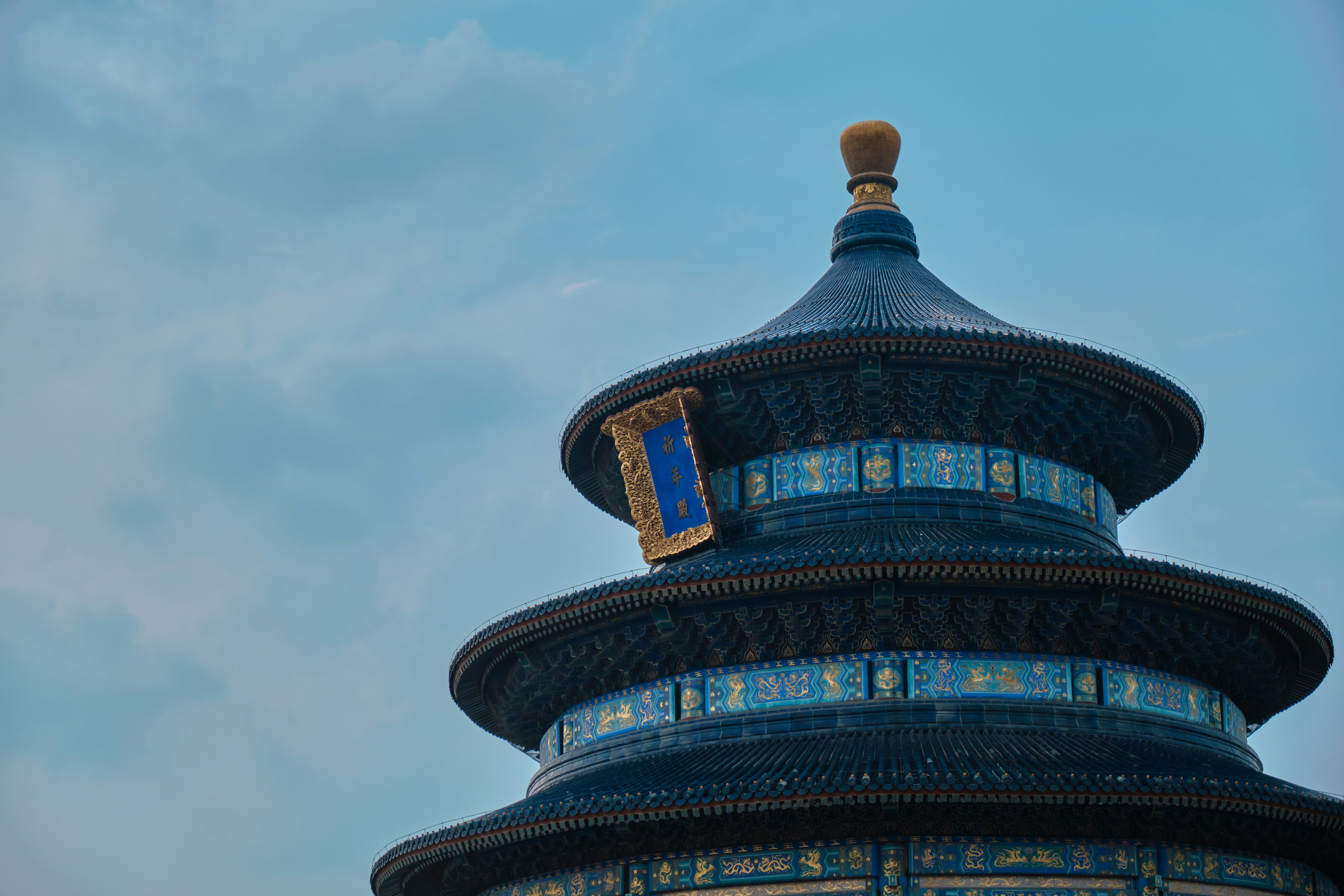 Ornate rooftop of a historic temple set against a clear blue sky.