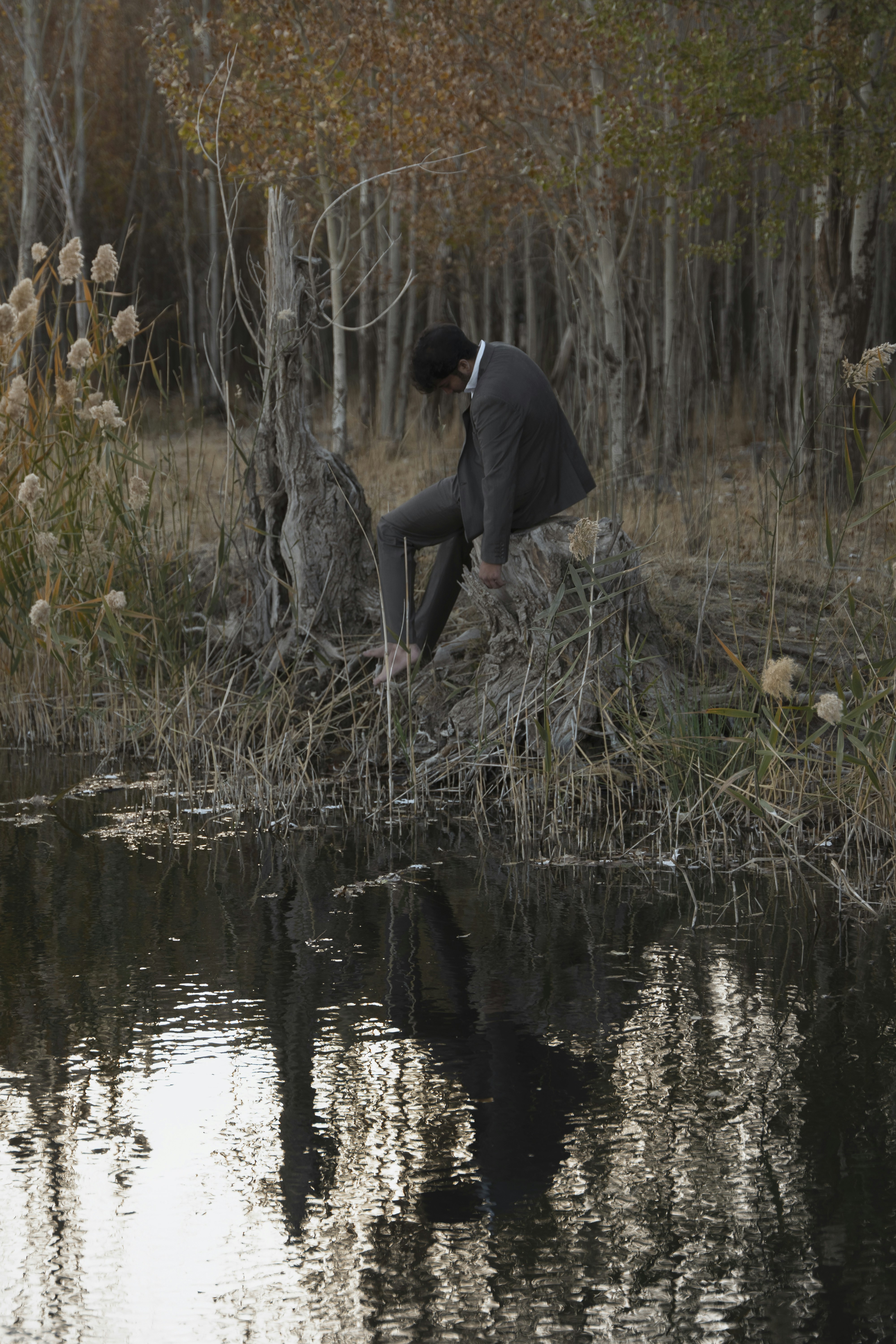 a person in a black jacket and a body of water