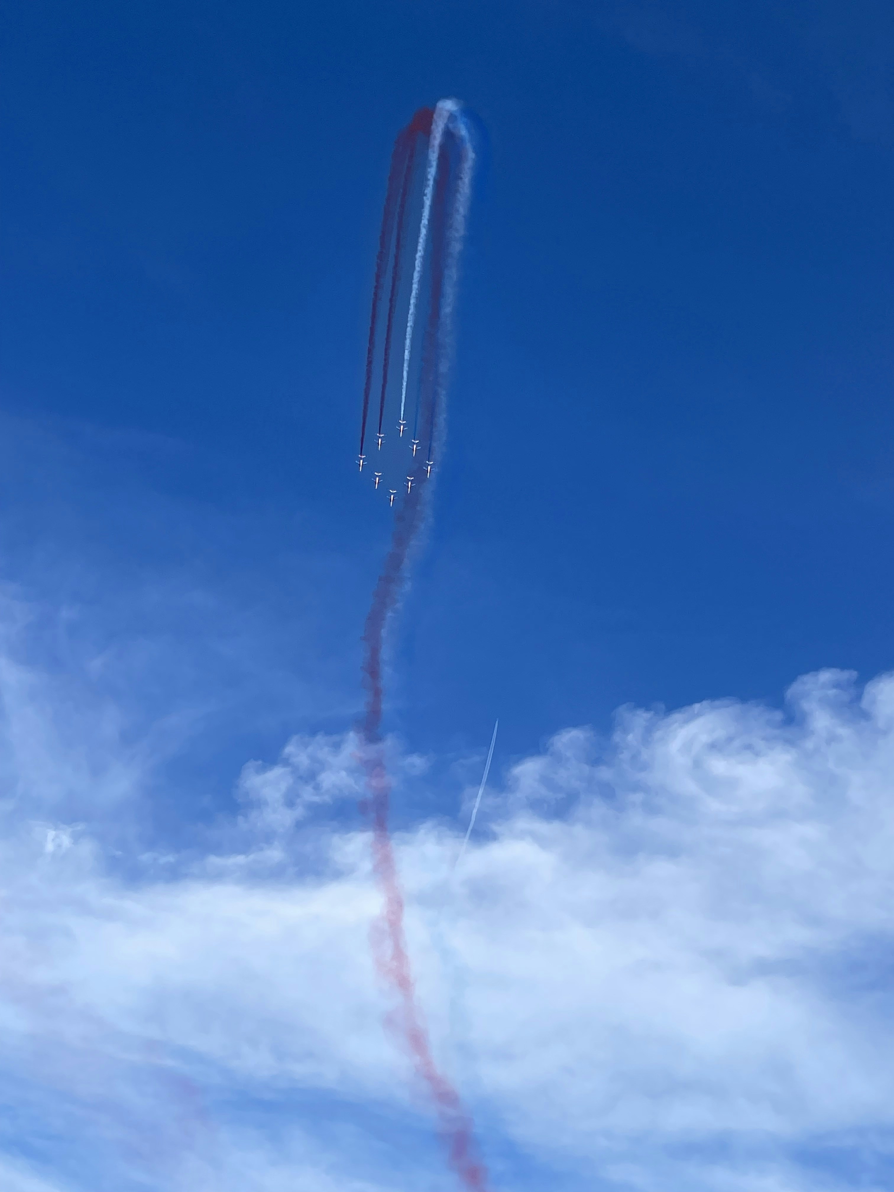 A red and white contrail flying through a blue sky photo – Free Sky ...