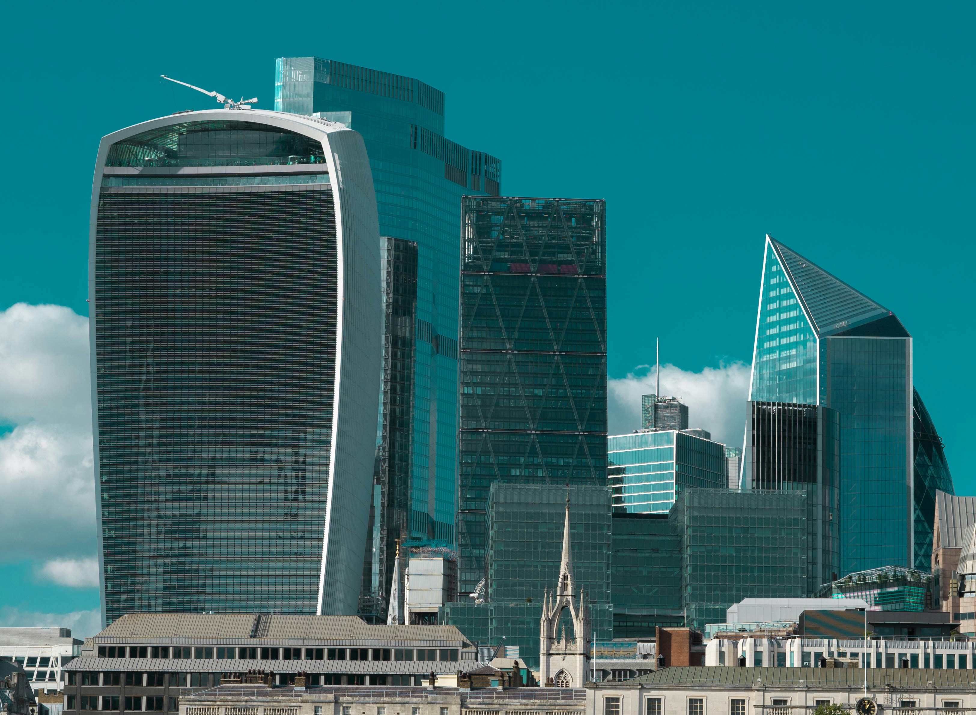 A collection of modern skyscrapers in a vibrant urban landscape, showcasing innovative architecture and reflective surfaces.