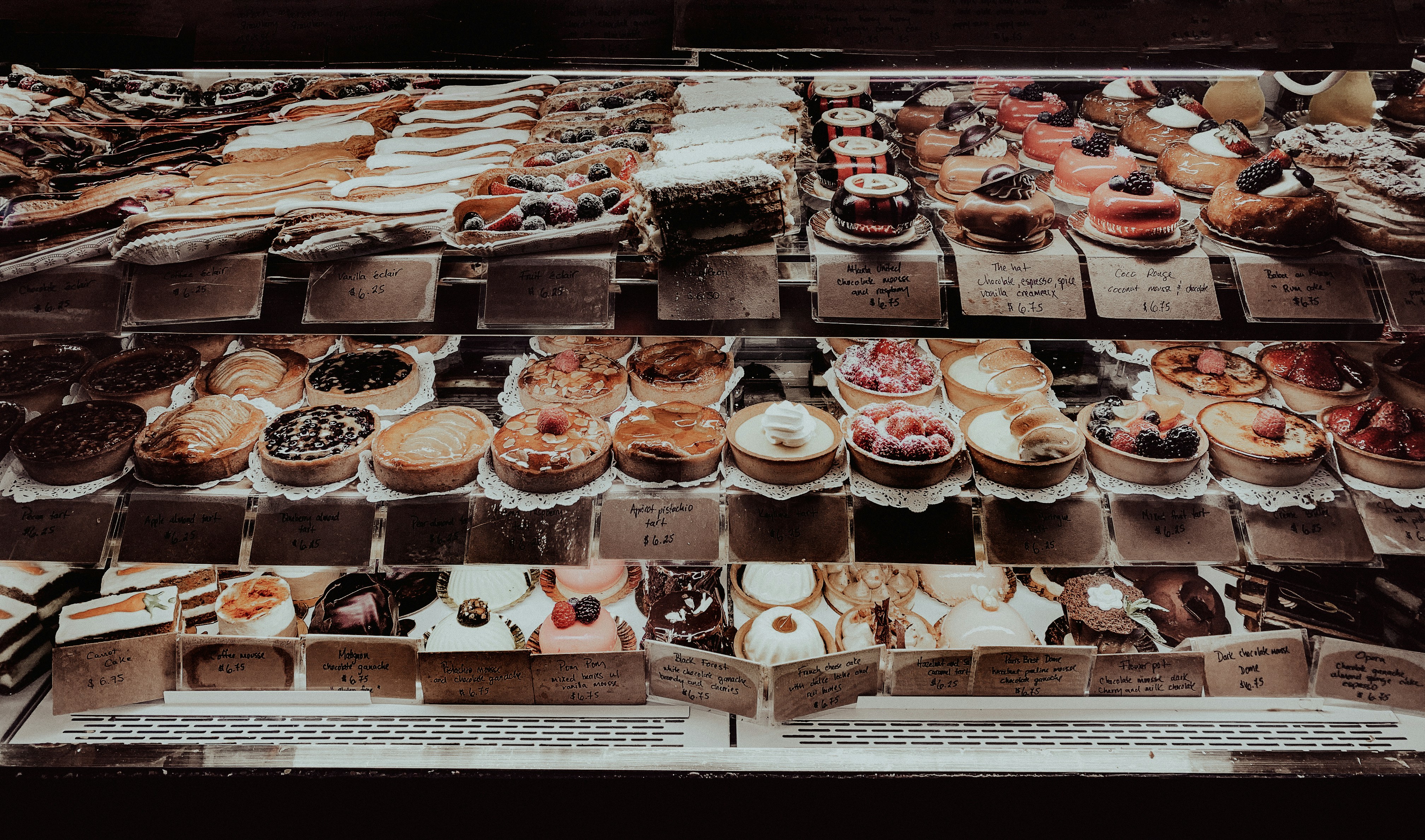 A display case filled with lots of different types of pastries photo ...
