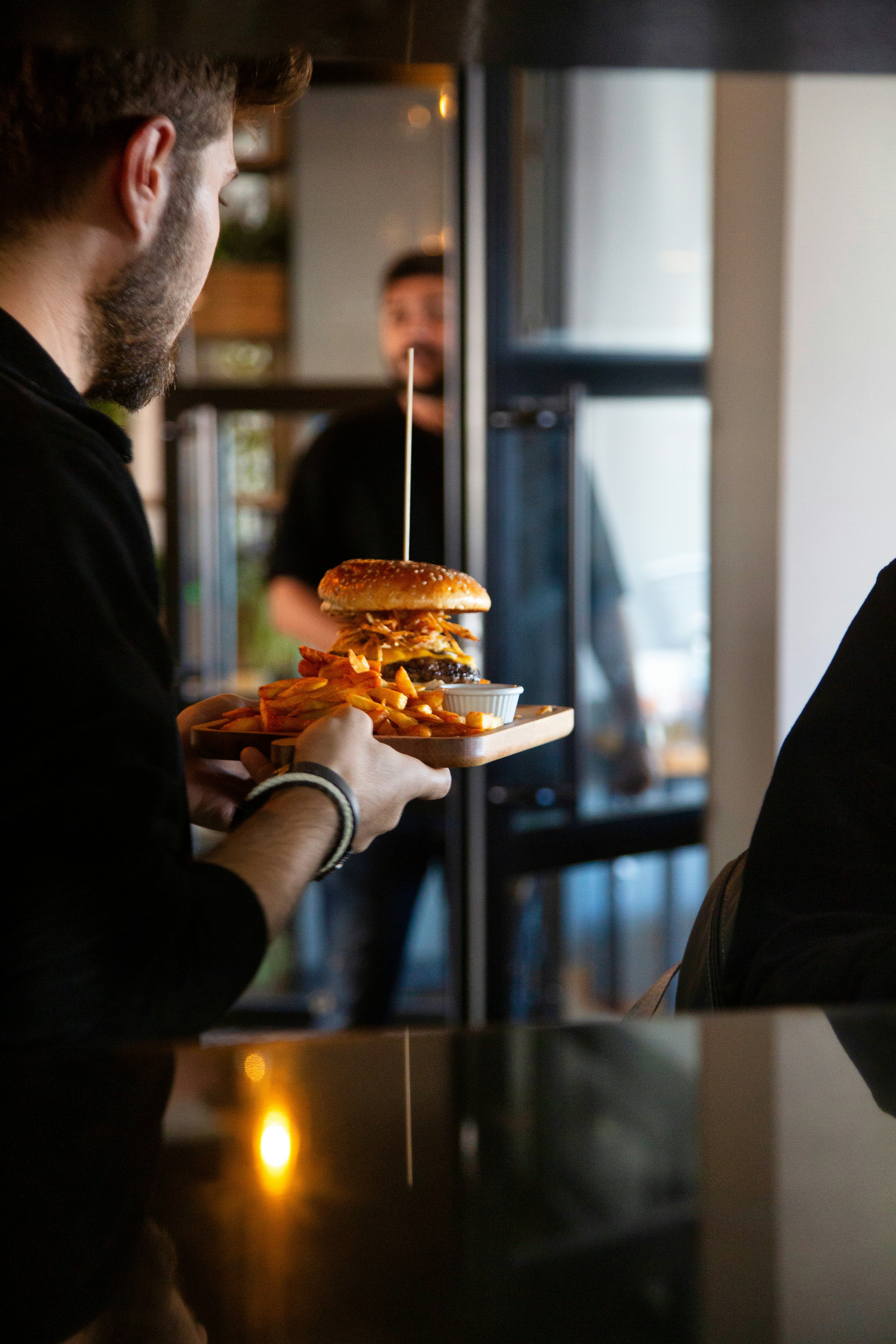 Serving a Gourmet Moment: A burger and fries on a wooden tray