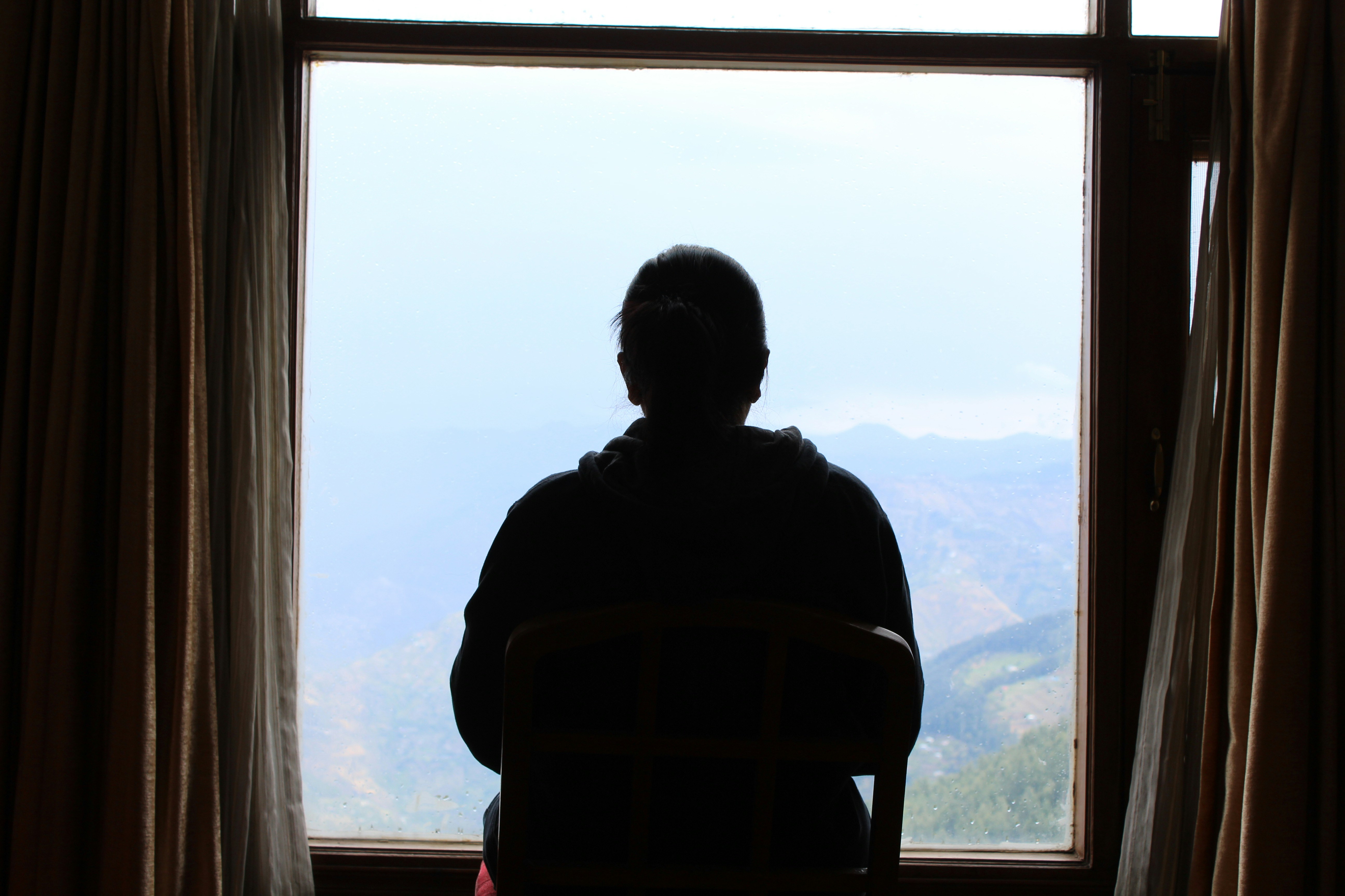 Frame of Silence: Seated Figure Gazes at the Mountain Window