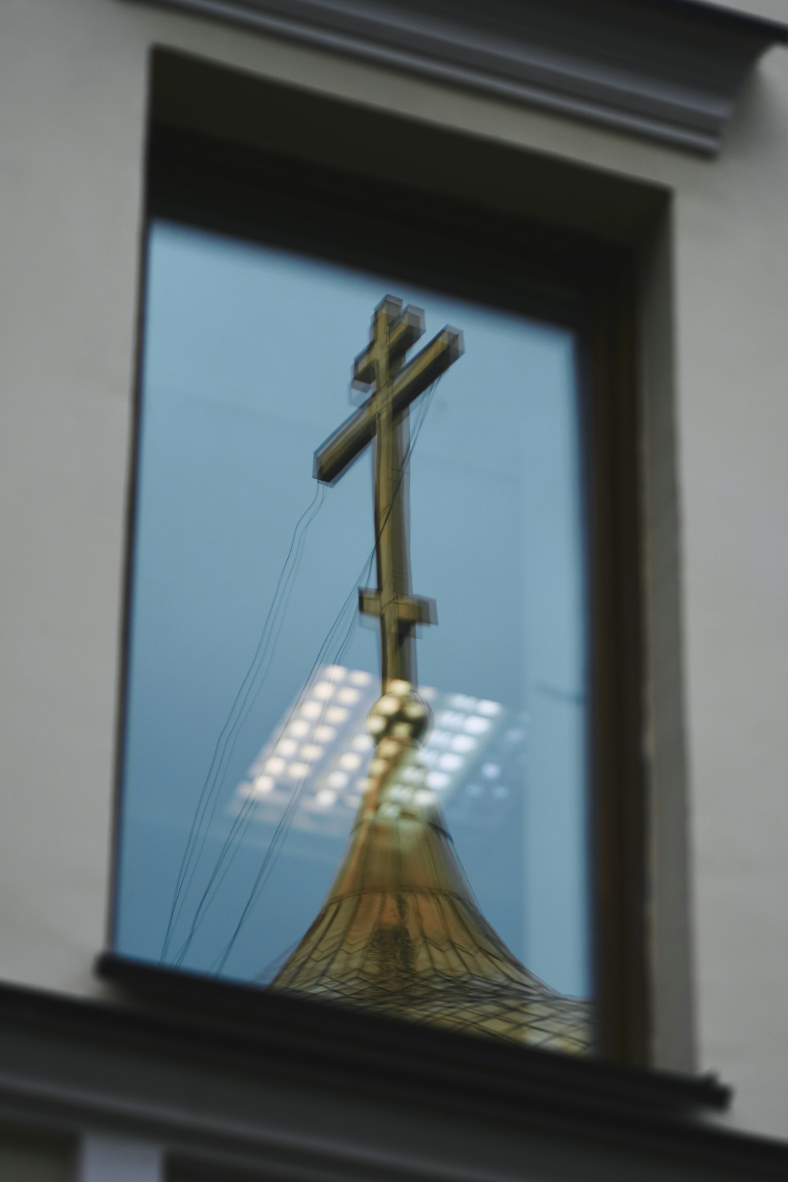 A reflection of a cross in a window photo – Free Blue Image on Unsplash