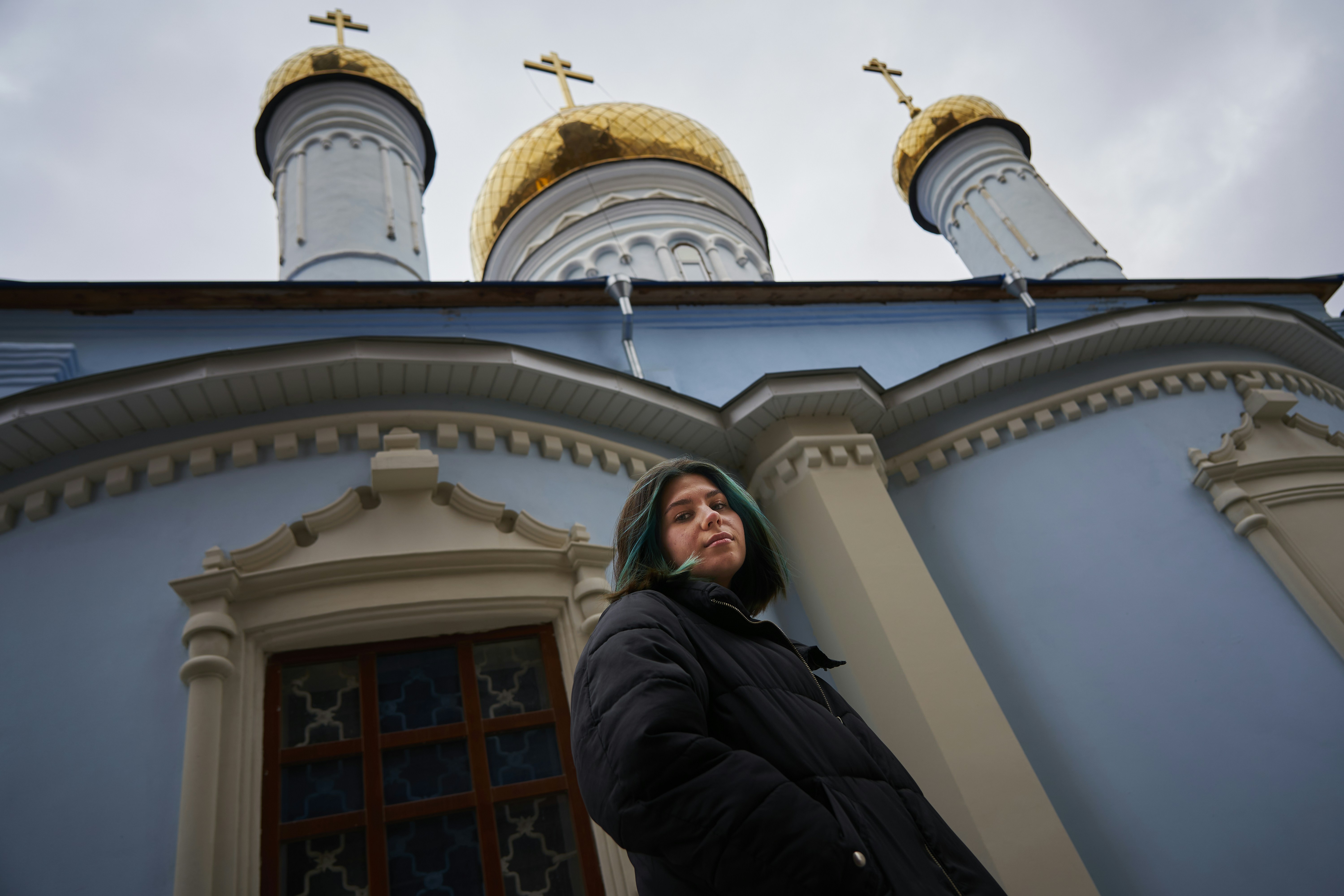 Low-angle Portrait Beneath Katedral Domes: Quiet Strength at the Blue Facade