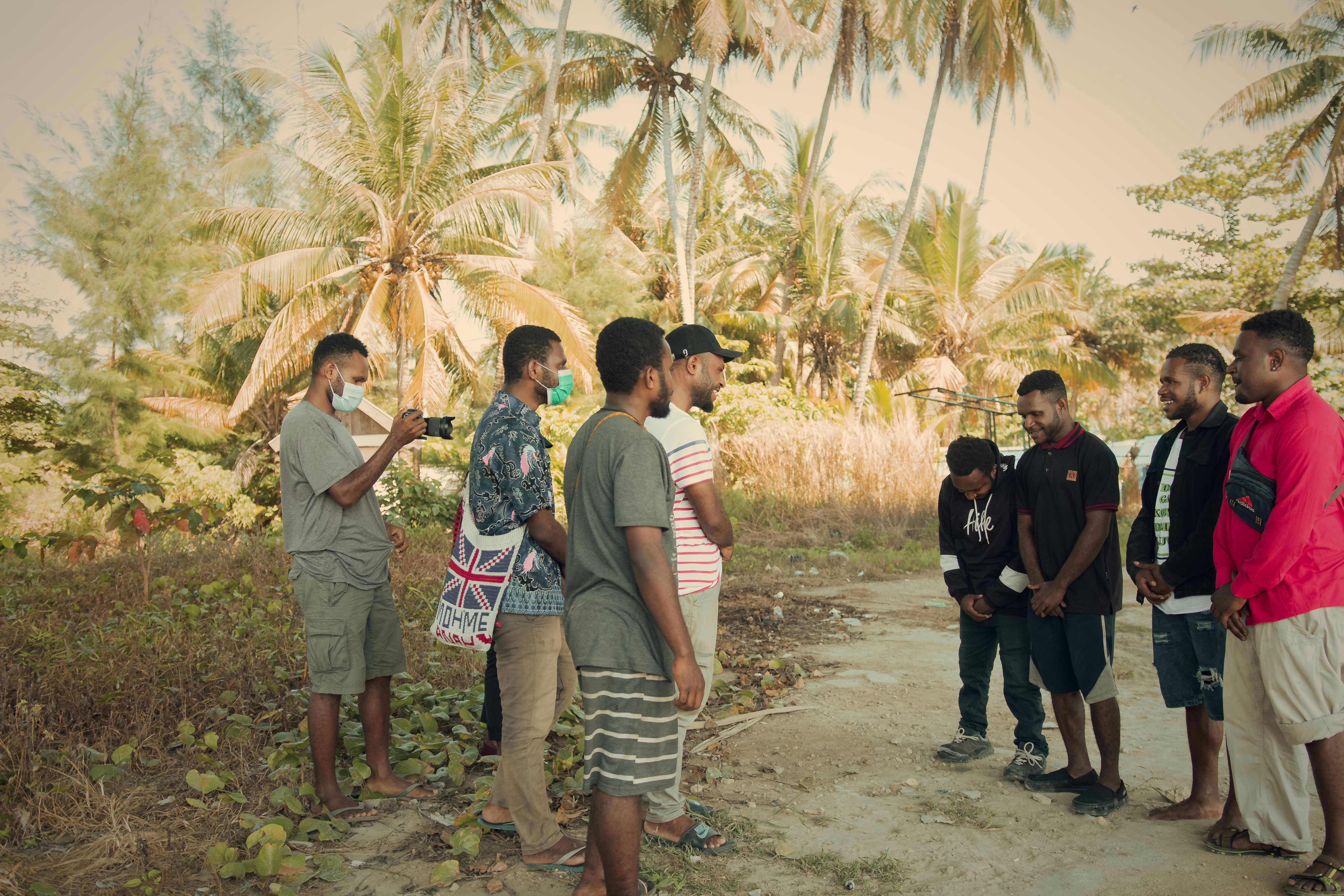 A group of young men standing around each other photo – Free Land Image ...