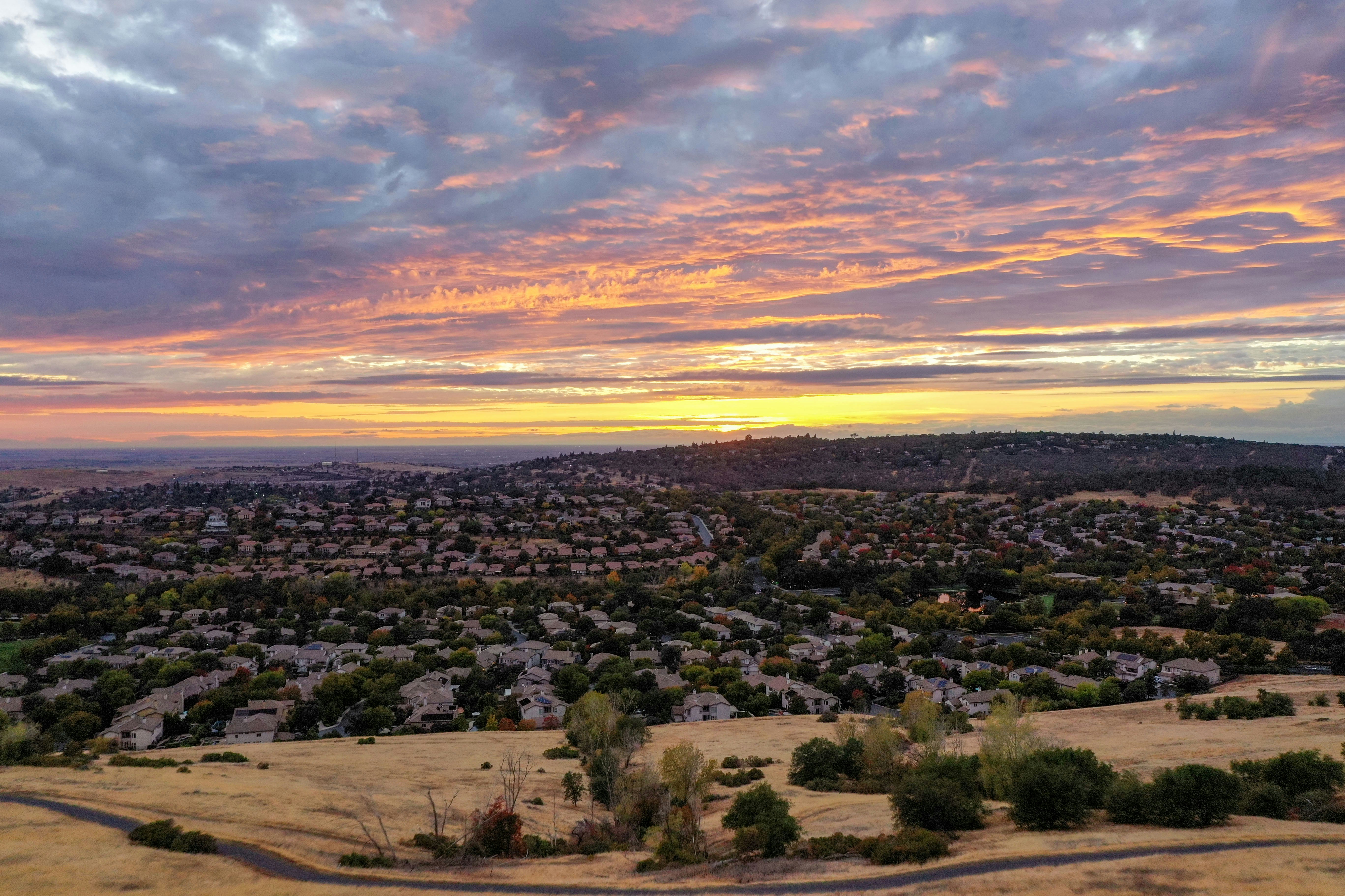 A beautiful sunset over a small town in the desert photo – Free ...