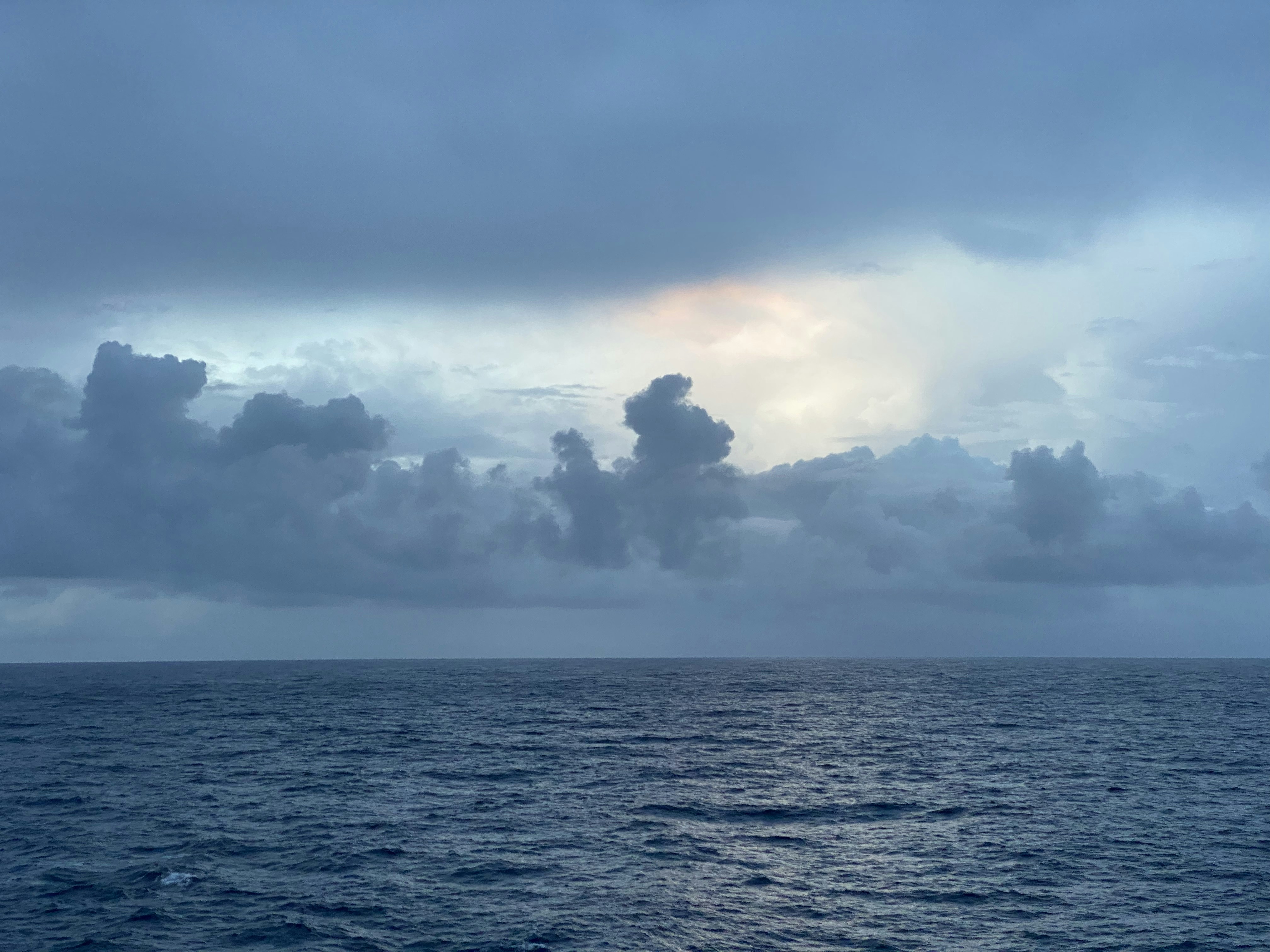 A large body of water under a cloudy sky photo – Free Nature Image on ...