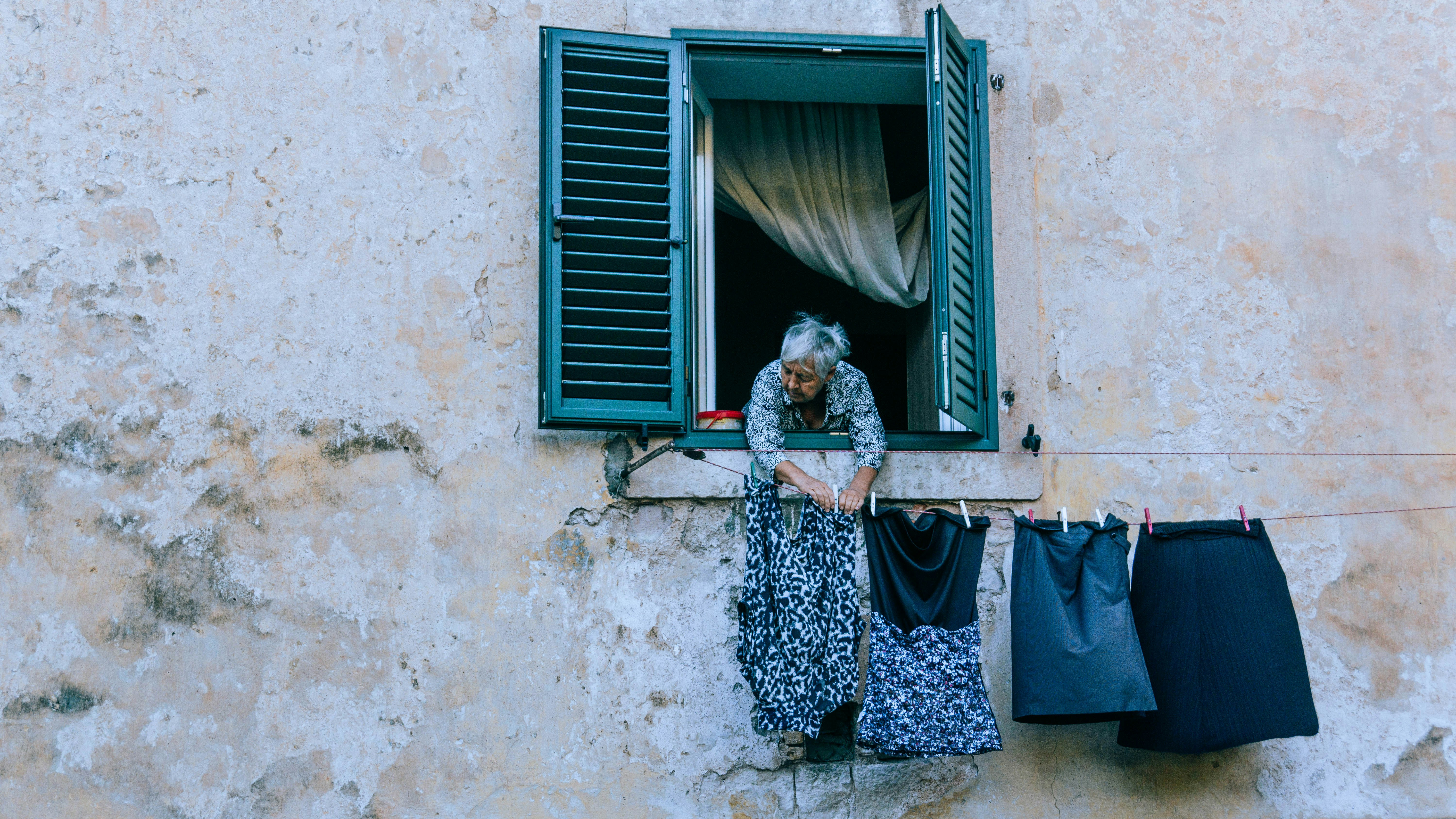 Windowed Laundry Day: An Elderly Gentlewoman at the Rustic Terrace