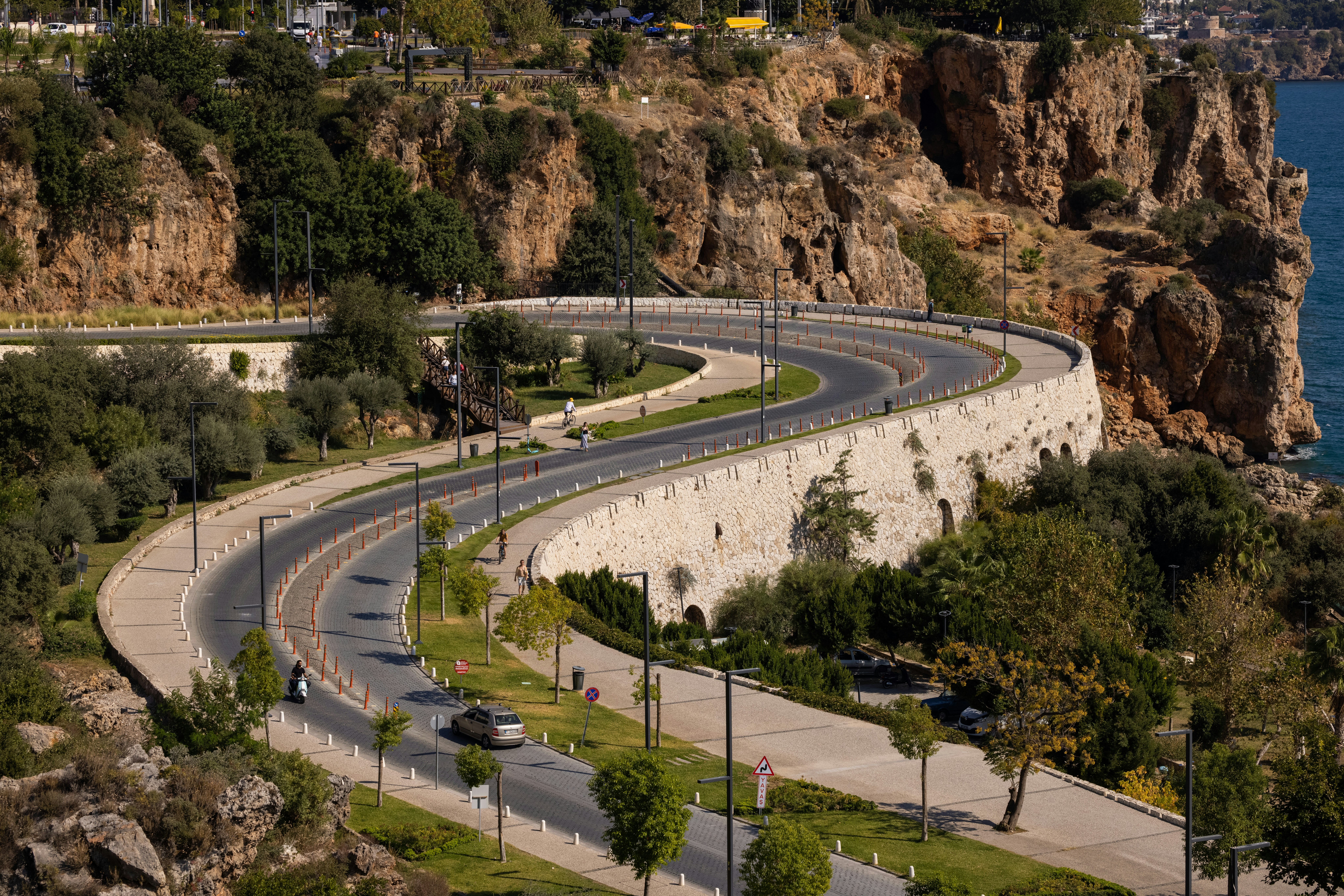 Cliffside Ribbon: The Winding Road Along Sunlit Rock