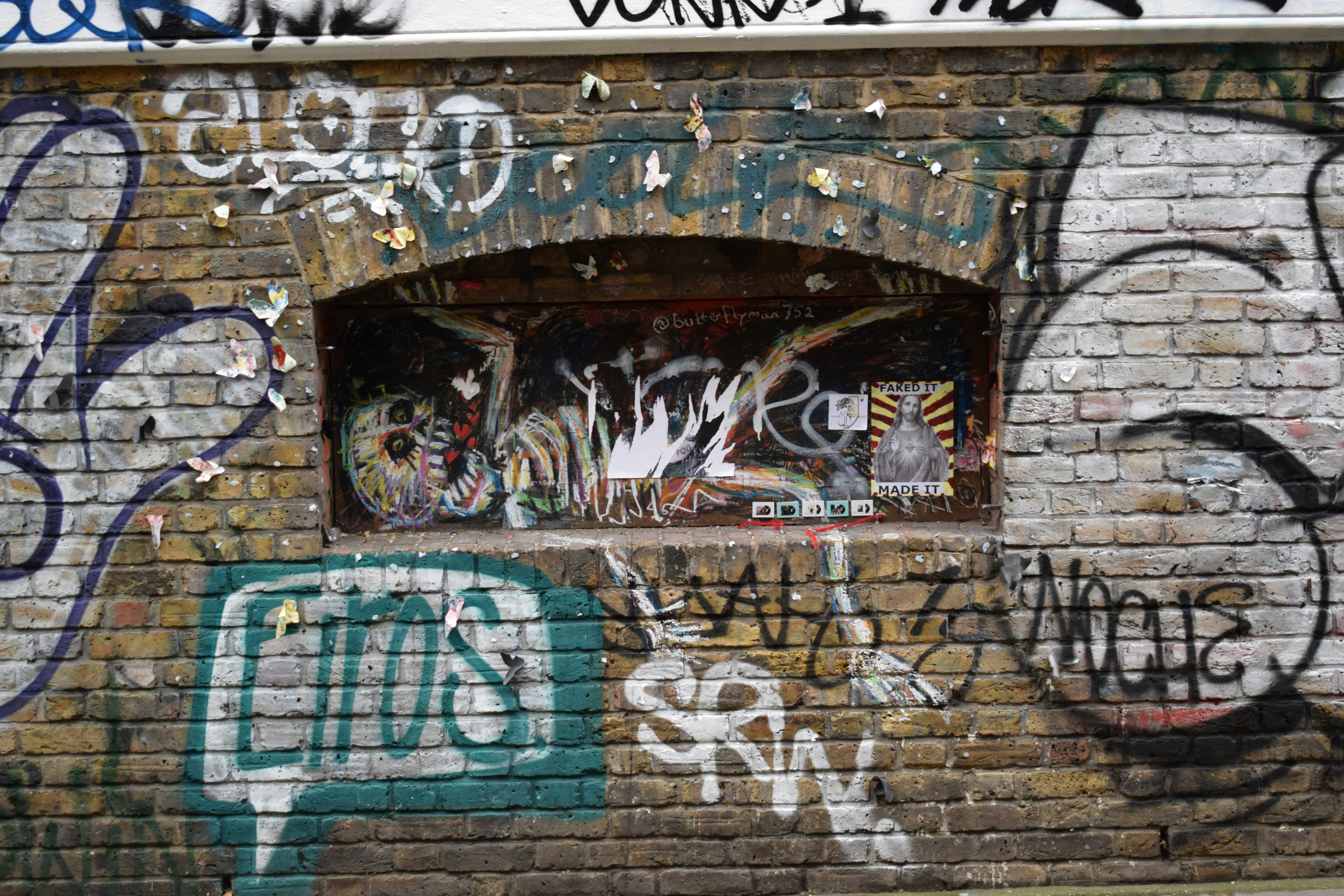 Graffiti Archway: A Weathered Brick Frame Framed in Colorful Vandal Decor
