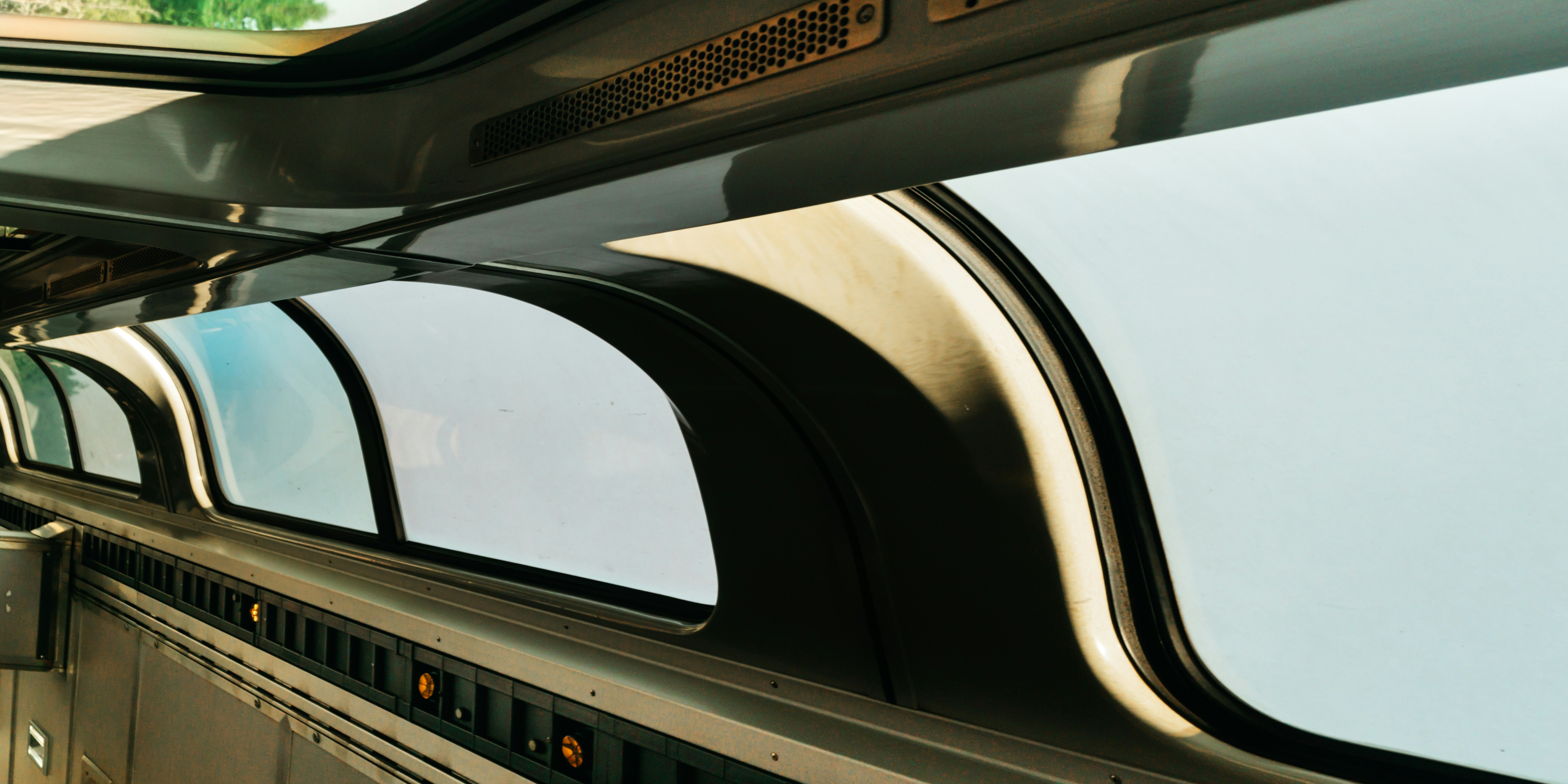 a view of the inside of a train looking out the window