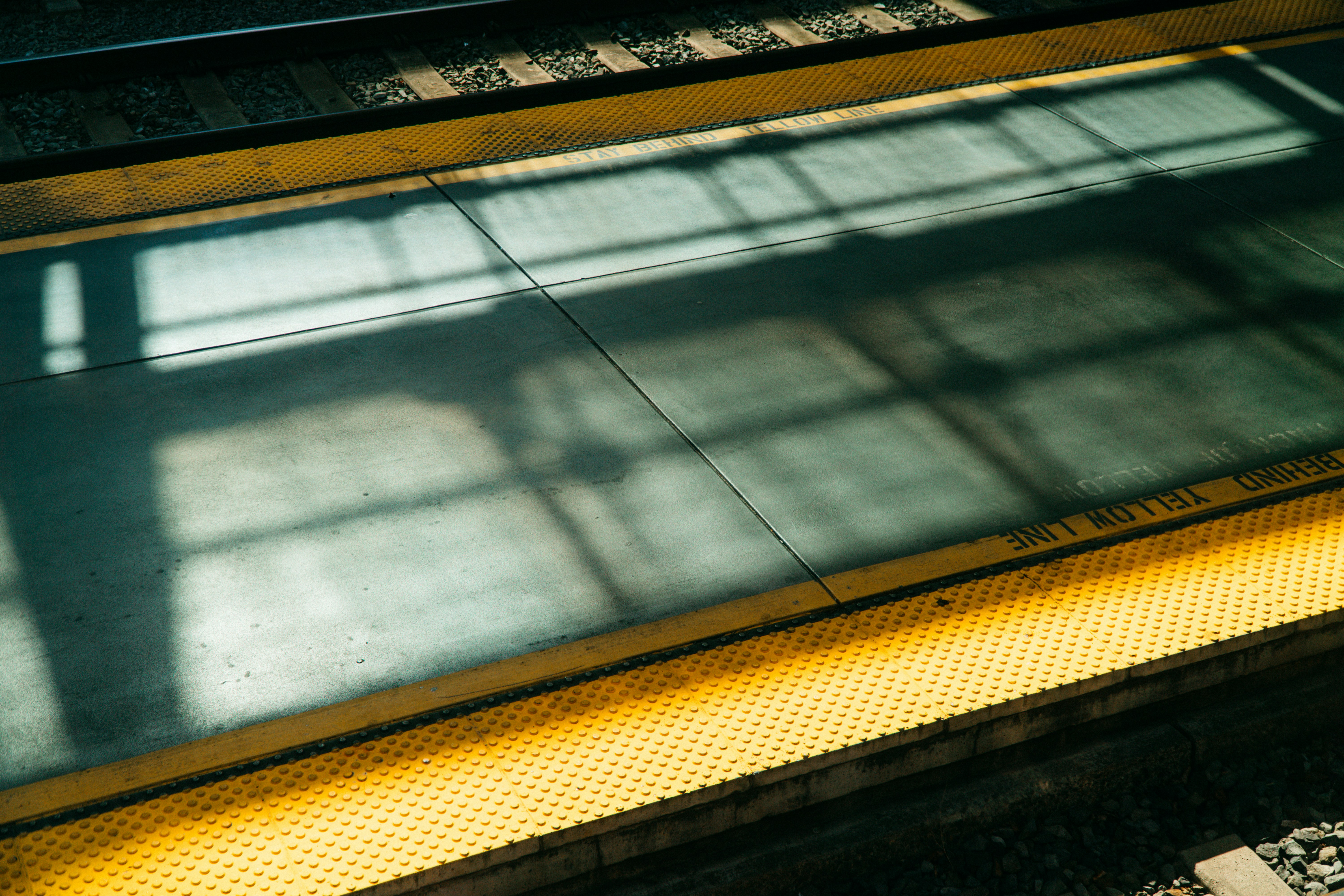 A train platform with a bench and a window photo – Free Street Image on ...