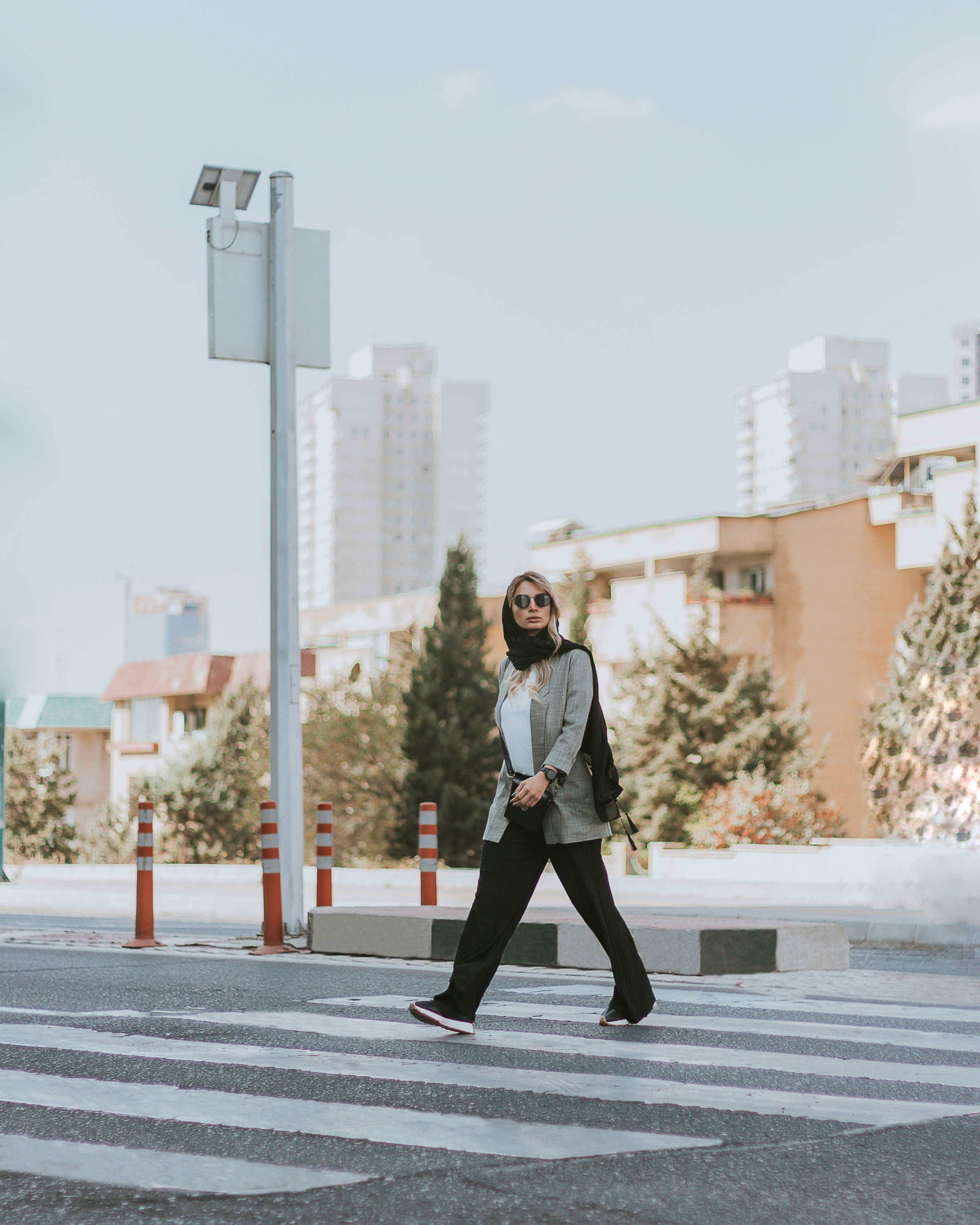 A woman crossing the street in a crosswalk photo – Free Asphalt Image ...