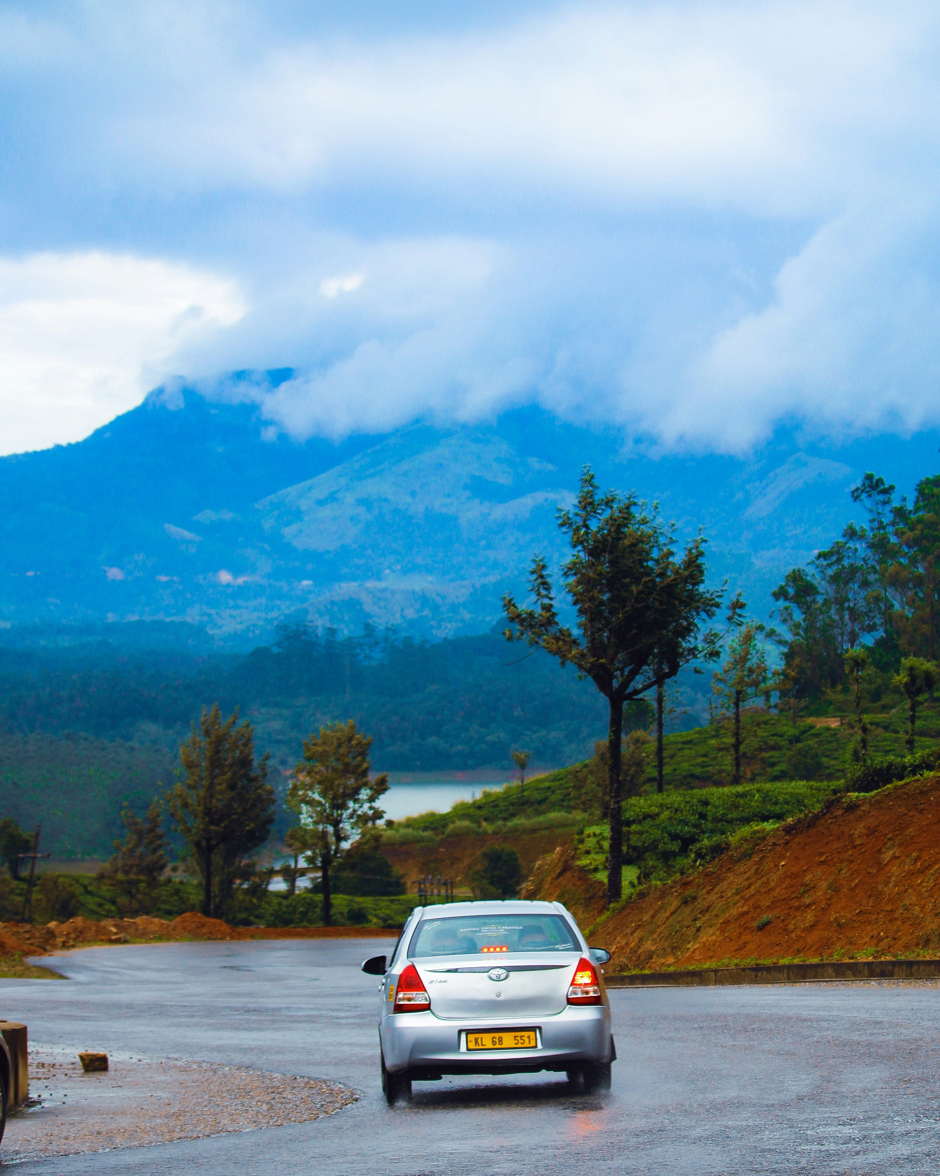 Silver Sedan on a Misty Mountain Road