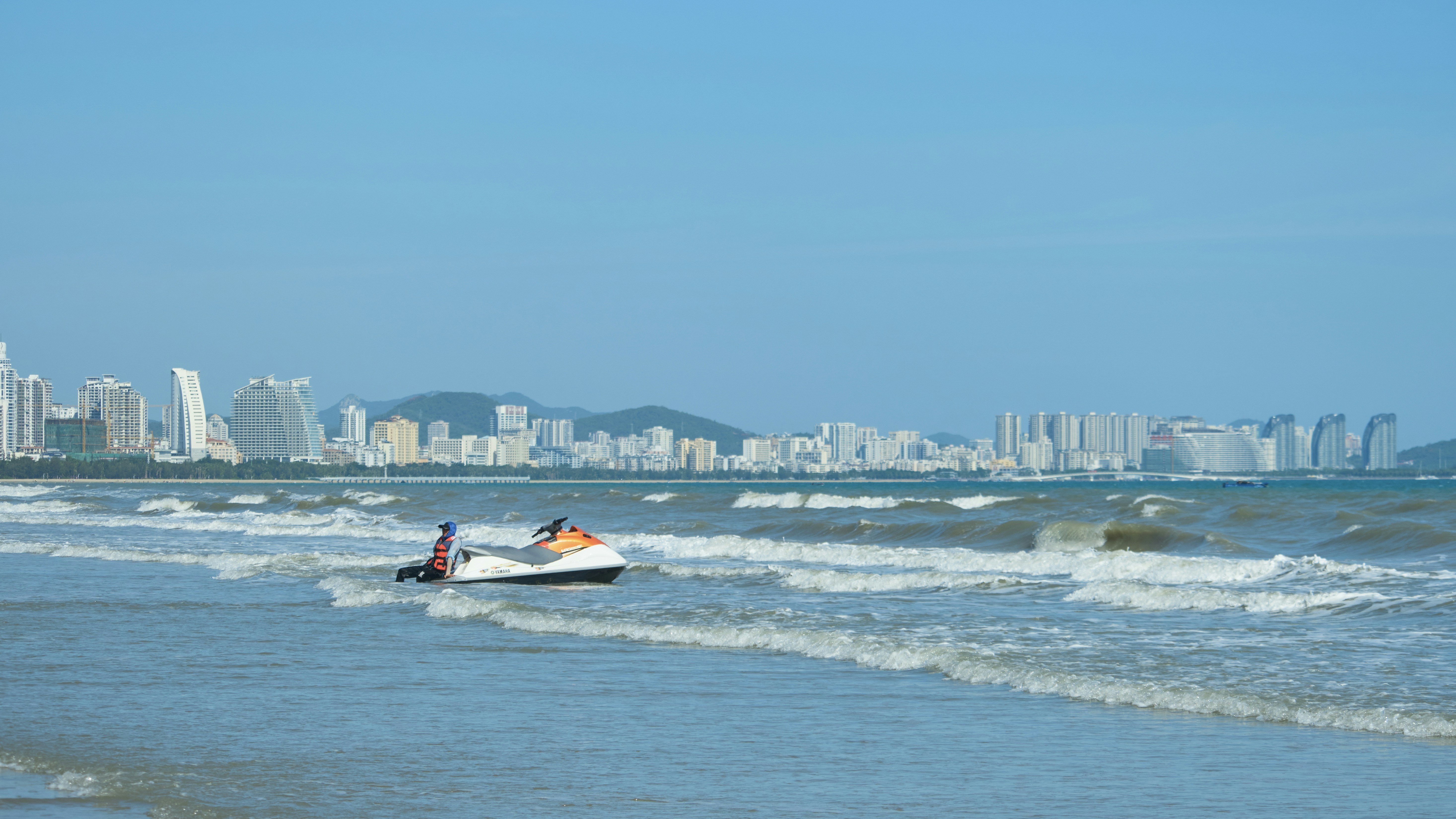 Wake Against the City Horizon: Jet Ski Sprint by the Shore