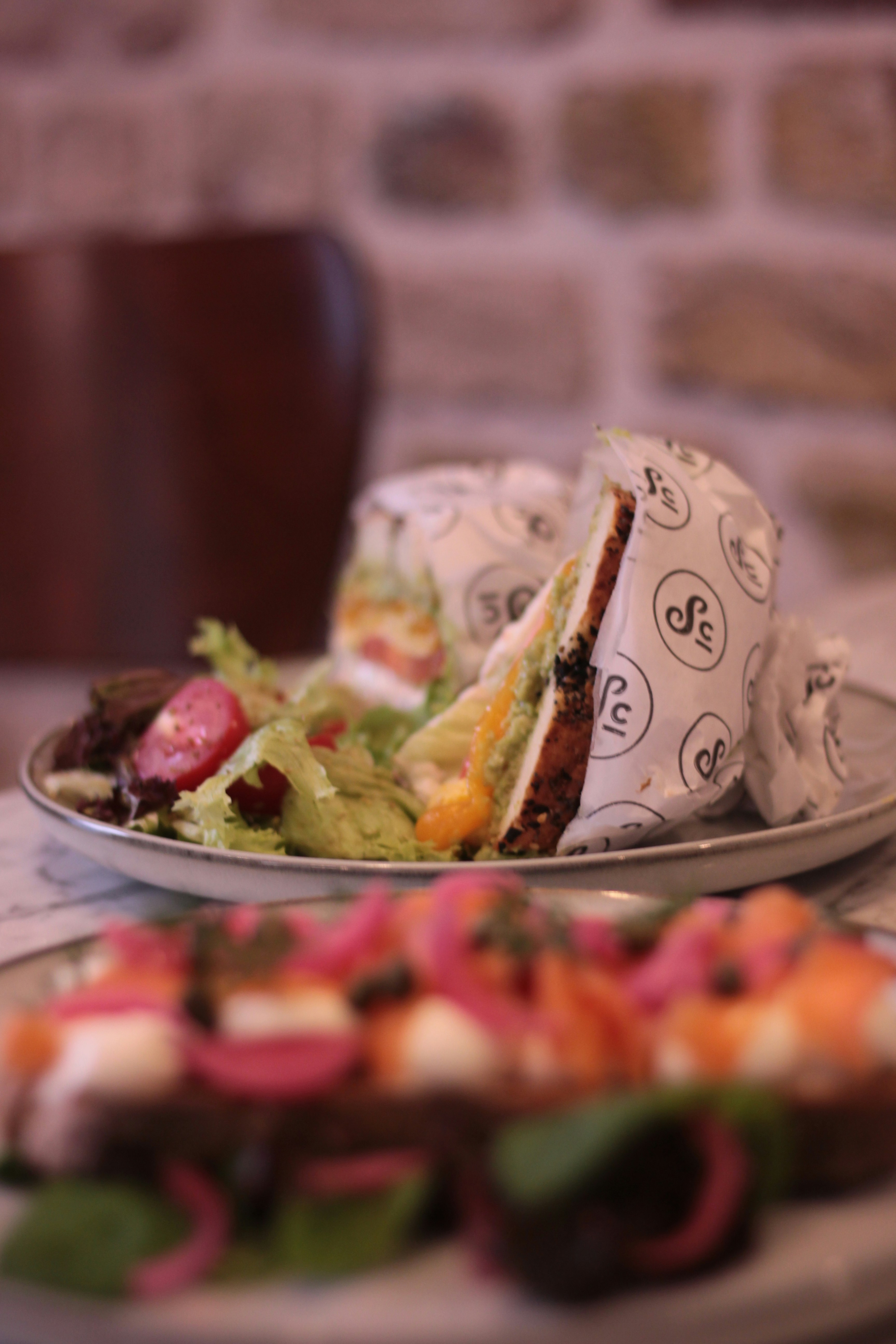 Cradled Falafel Wraps and a Garden Plate in Soft Evening Light