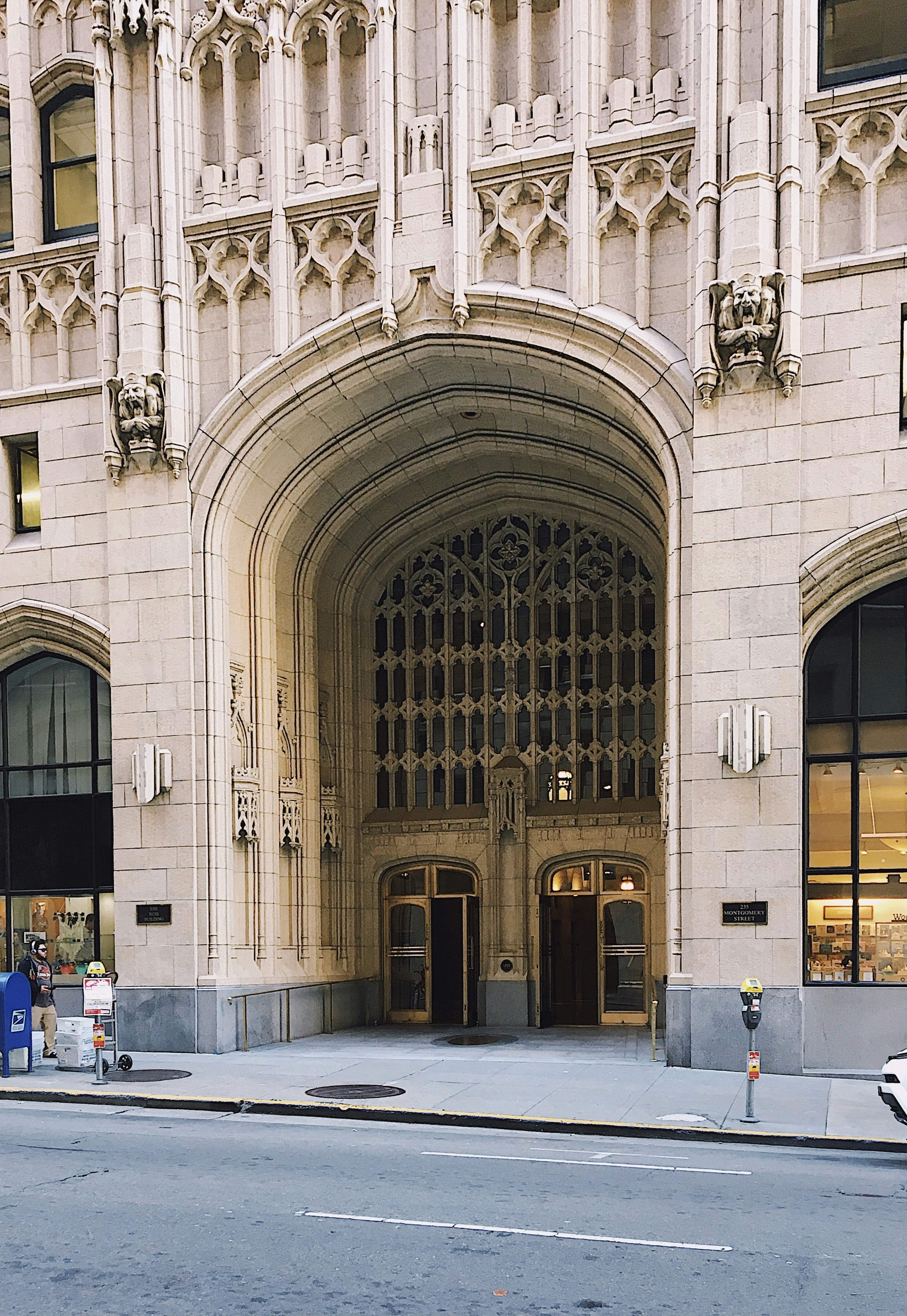 Gateway of Stone: An Ornate Gothic Archway Anchoring a Quiet City Street