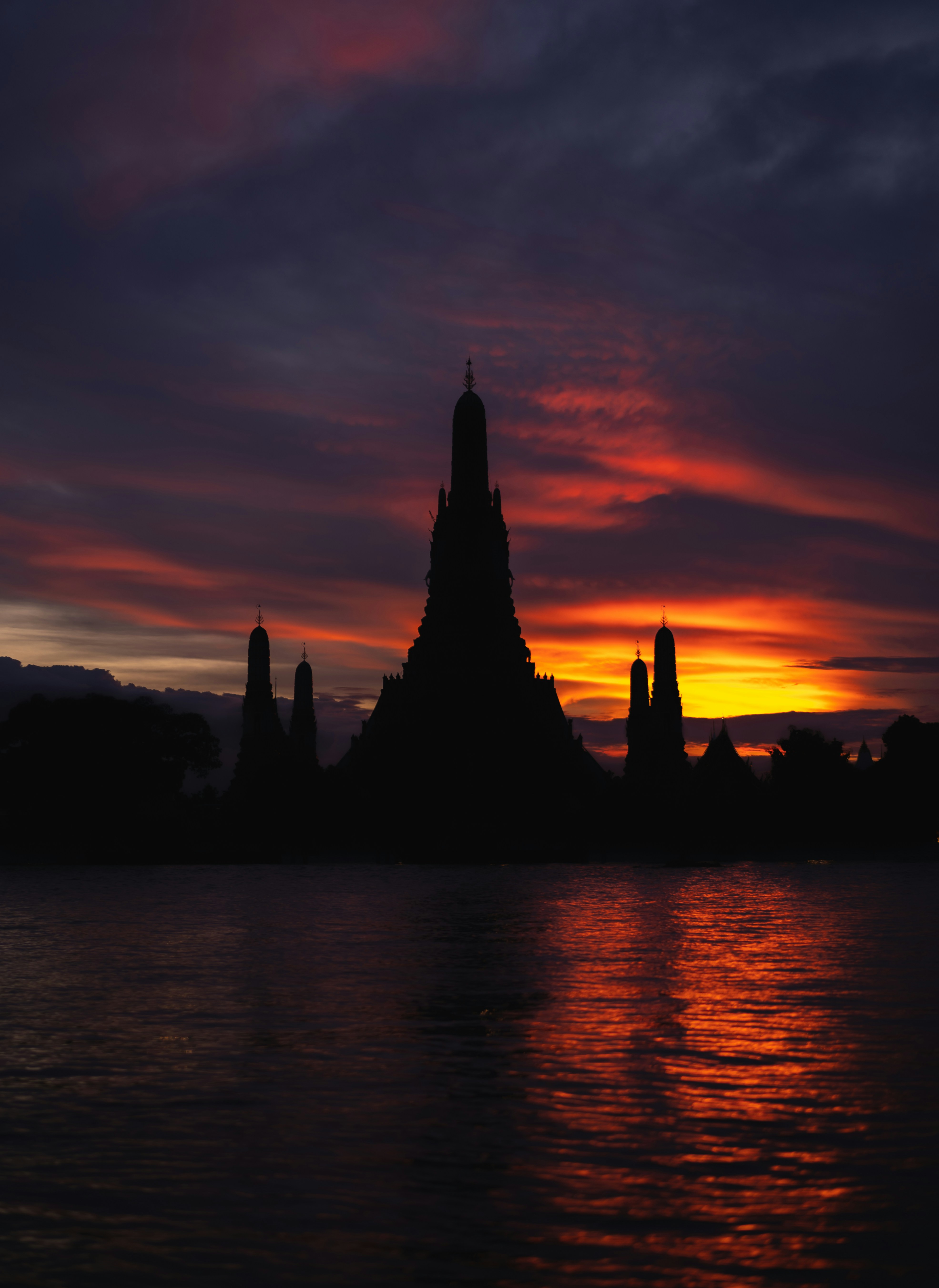 a very tall tower sitting in the middle of a body of water