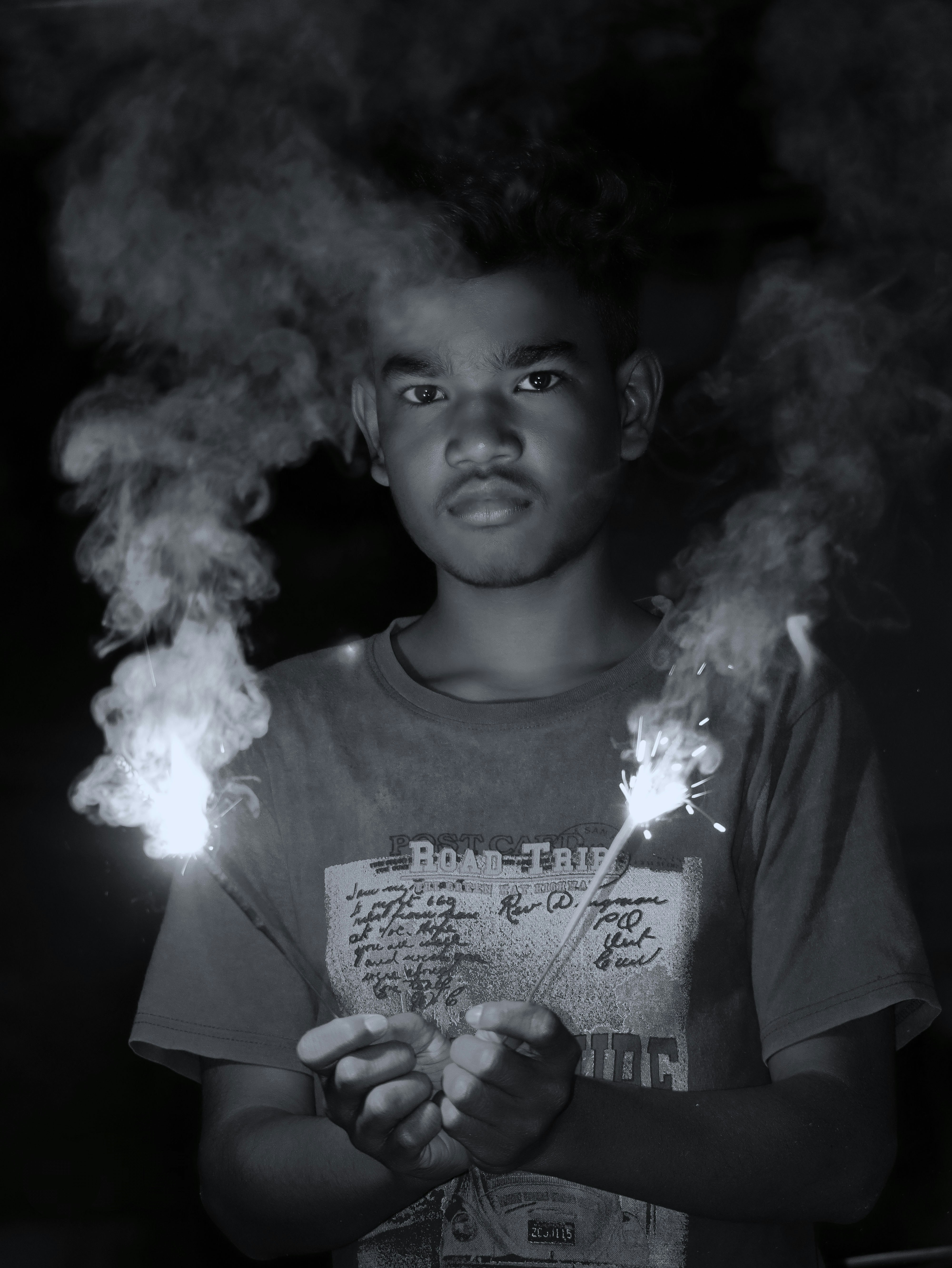 a young boy holding a lit match in his hands