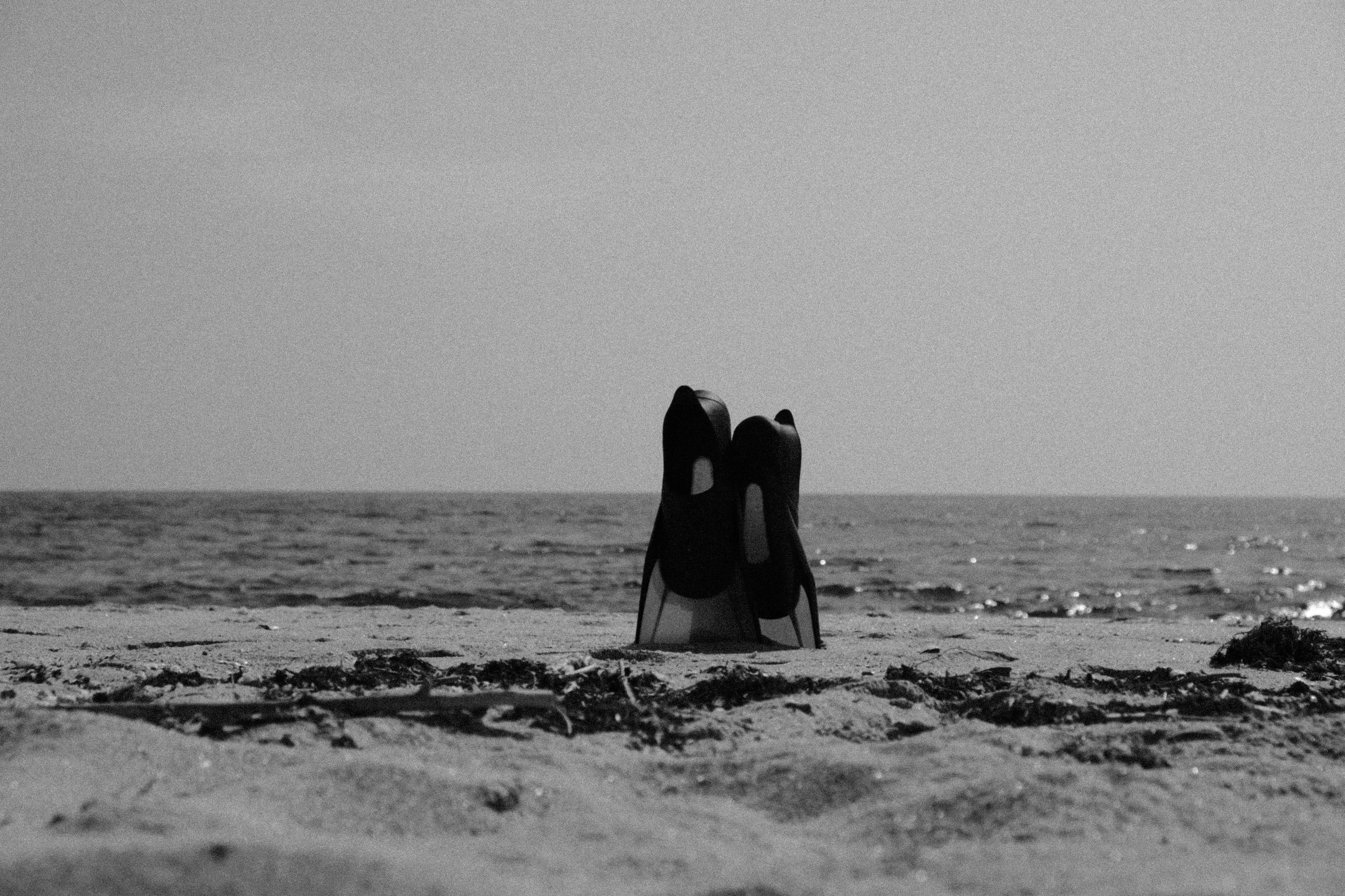 Twin Sandals at the Edge: A Quiet Beach Moment