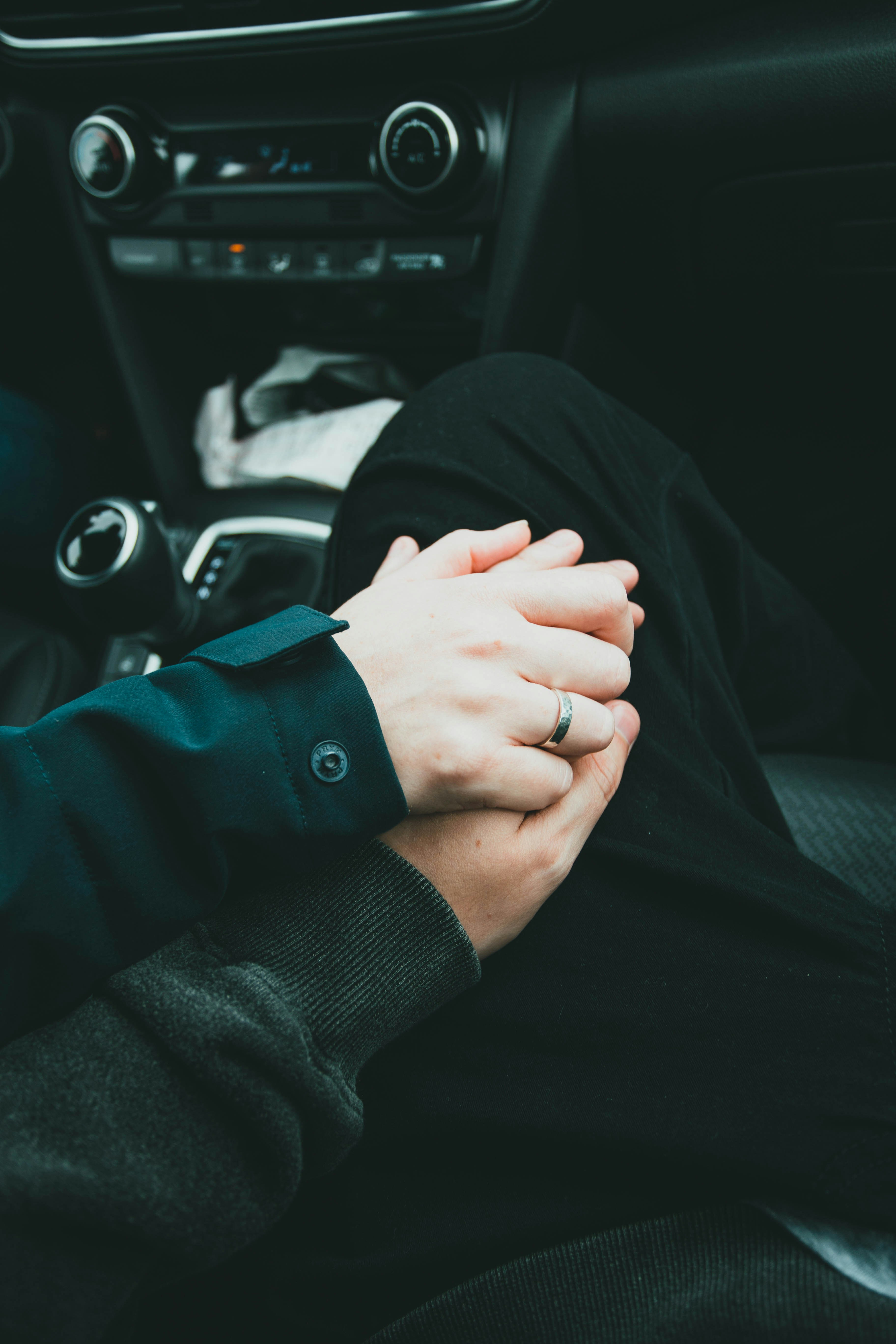 Interlaced Hands in the Passenger Seat
