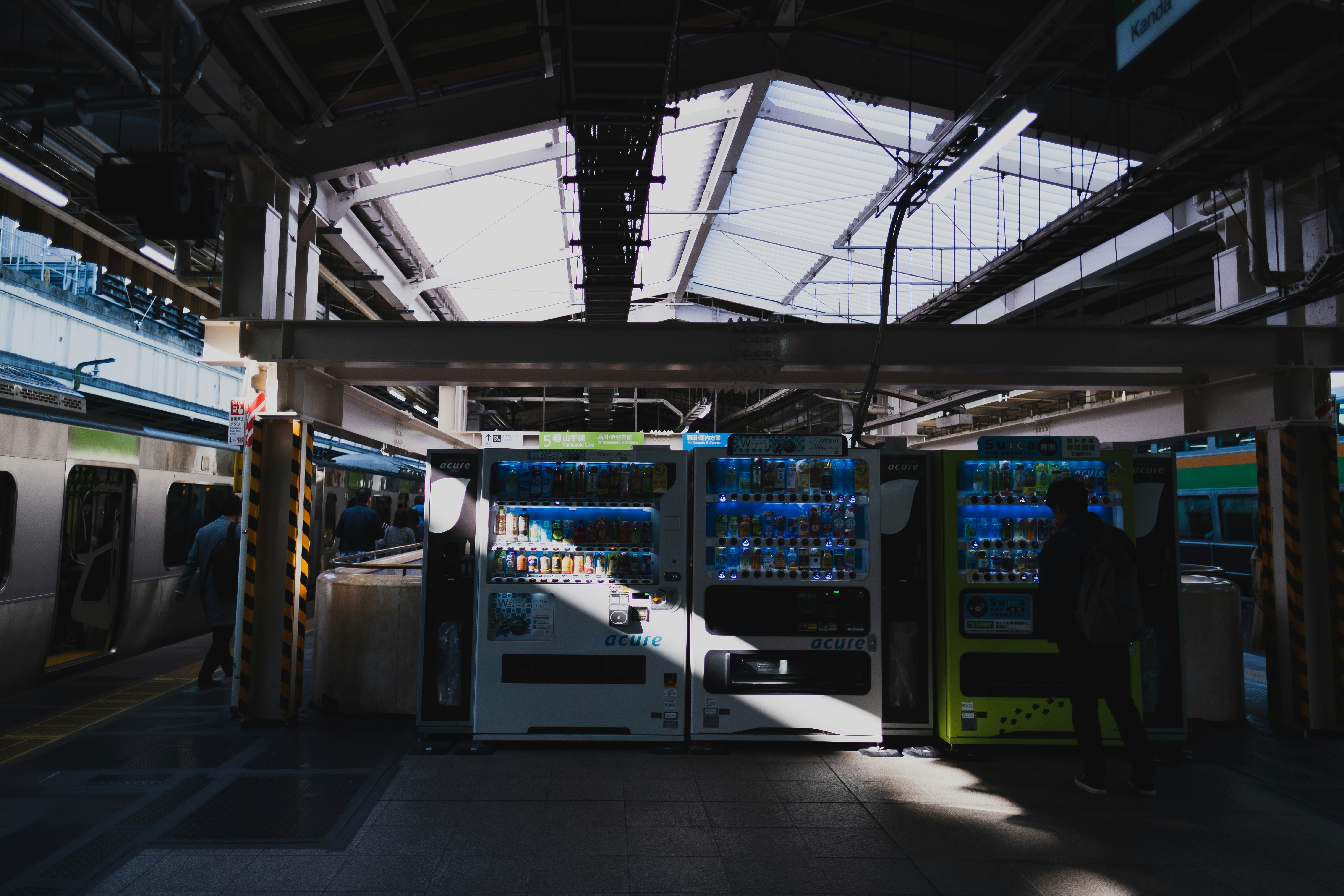 Views around Tokyo. | a train station with a row of vending machines
