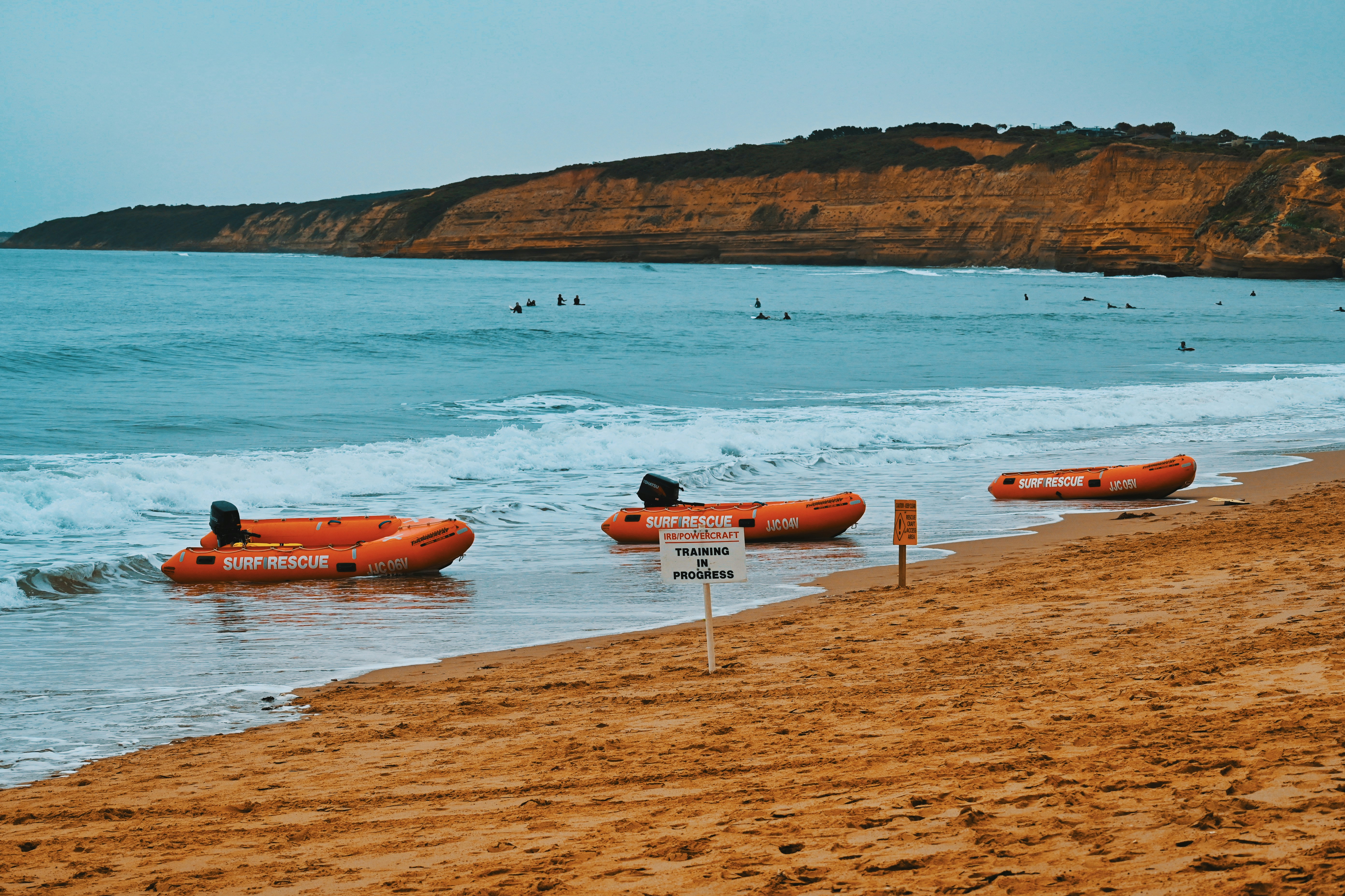 A group of rafts sitting on top of a sandy beach photo – Free Jan juc ...