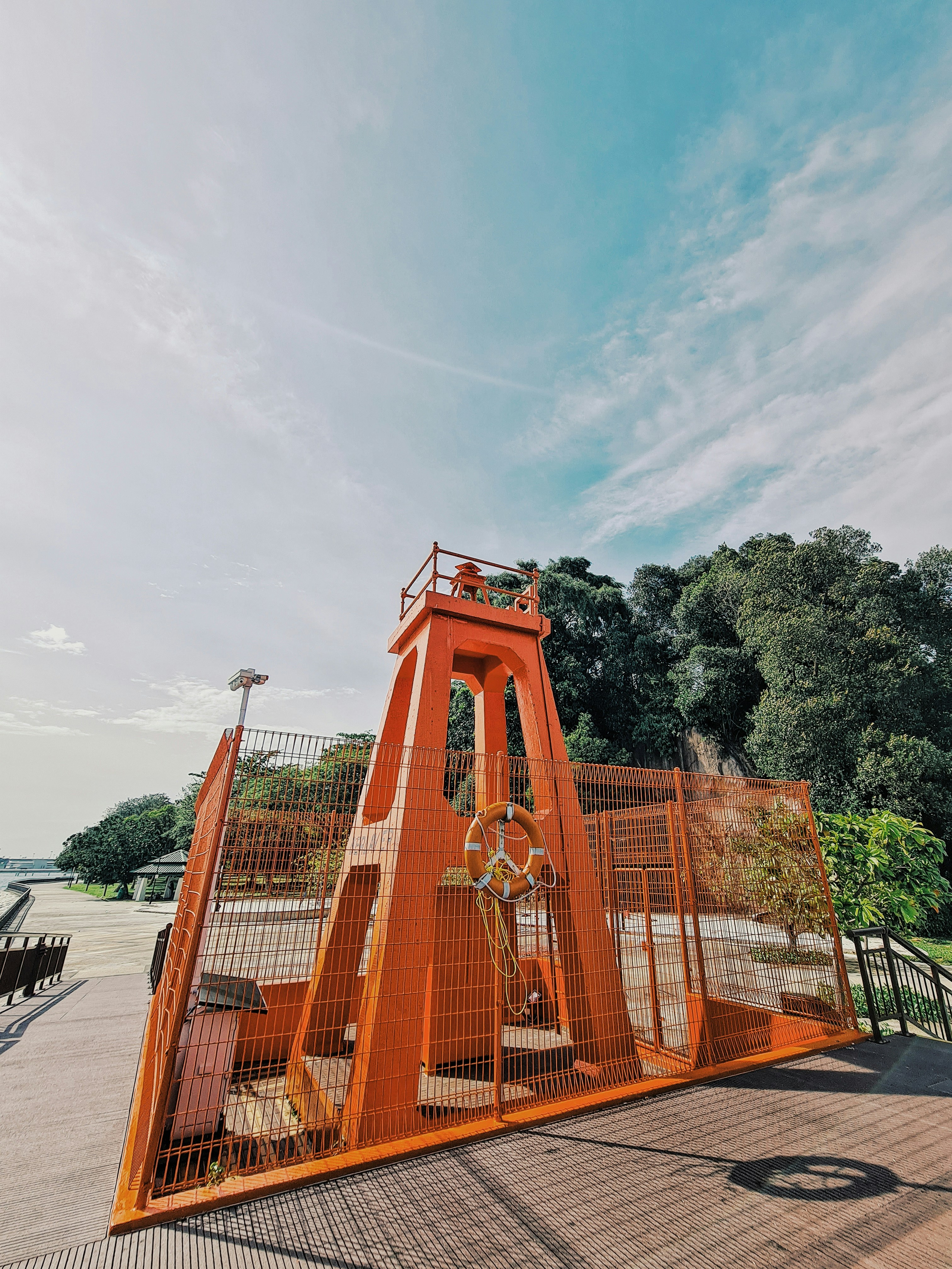a tall orange structure with a clock on top of it