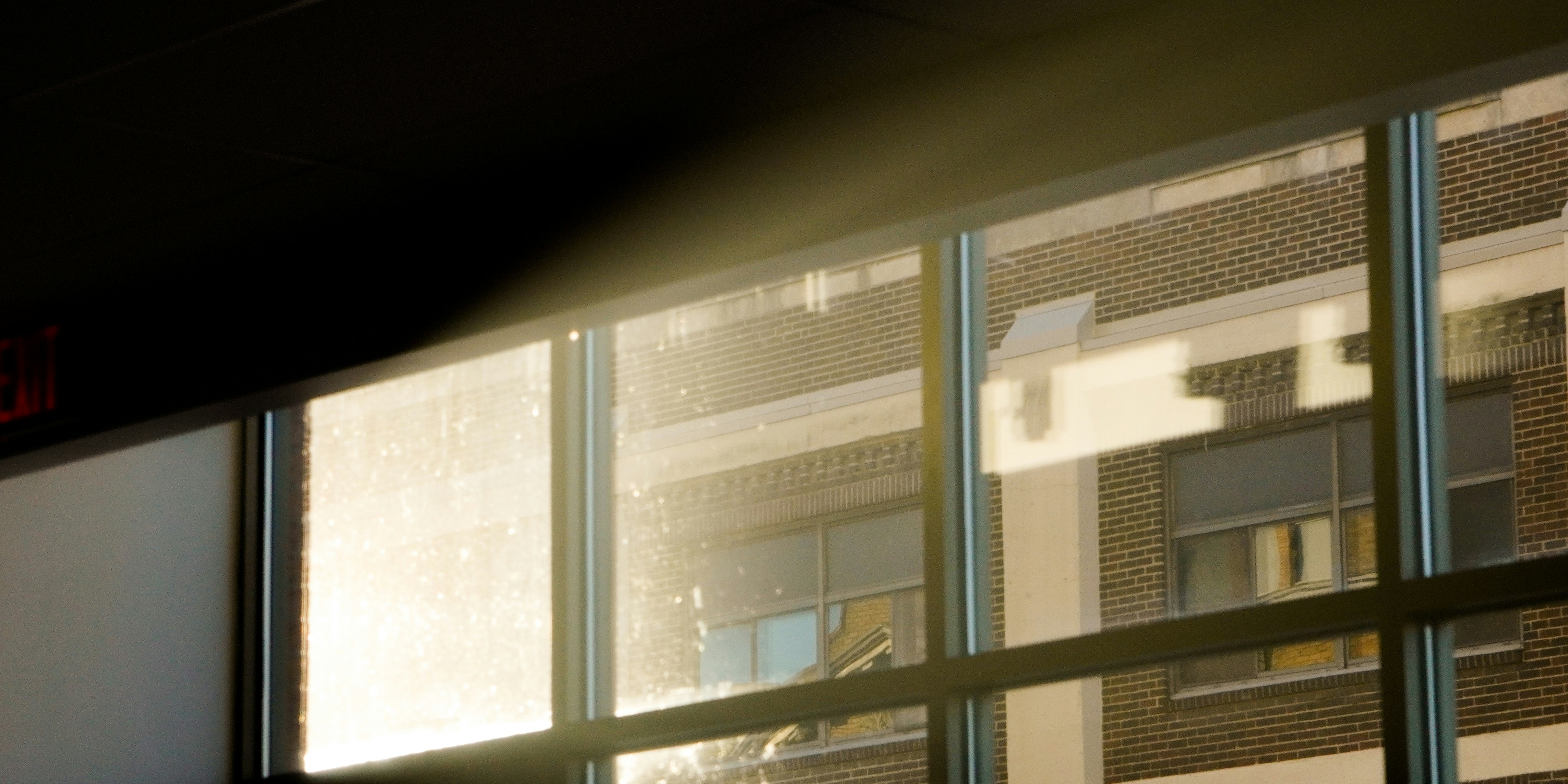 Sunlight streaming through a window illuminates a modern building interior.