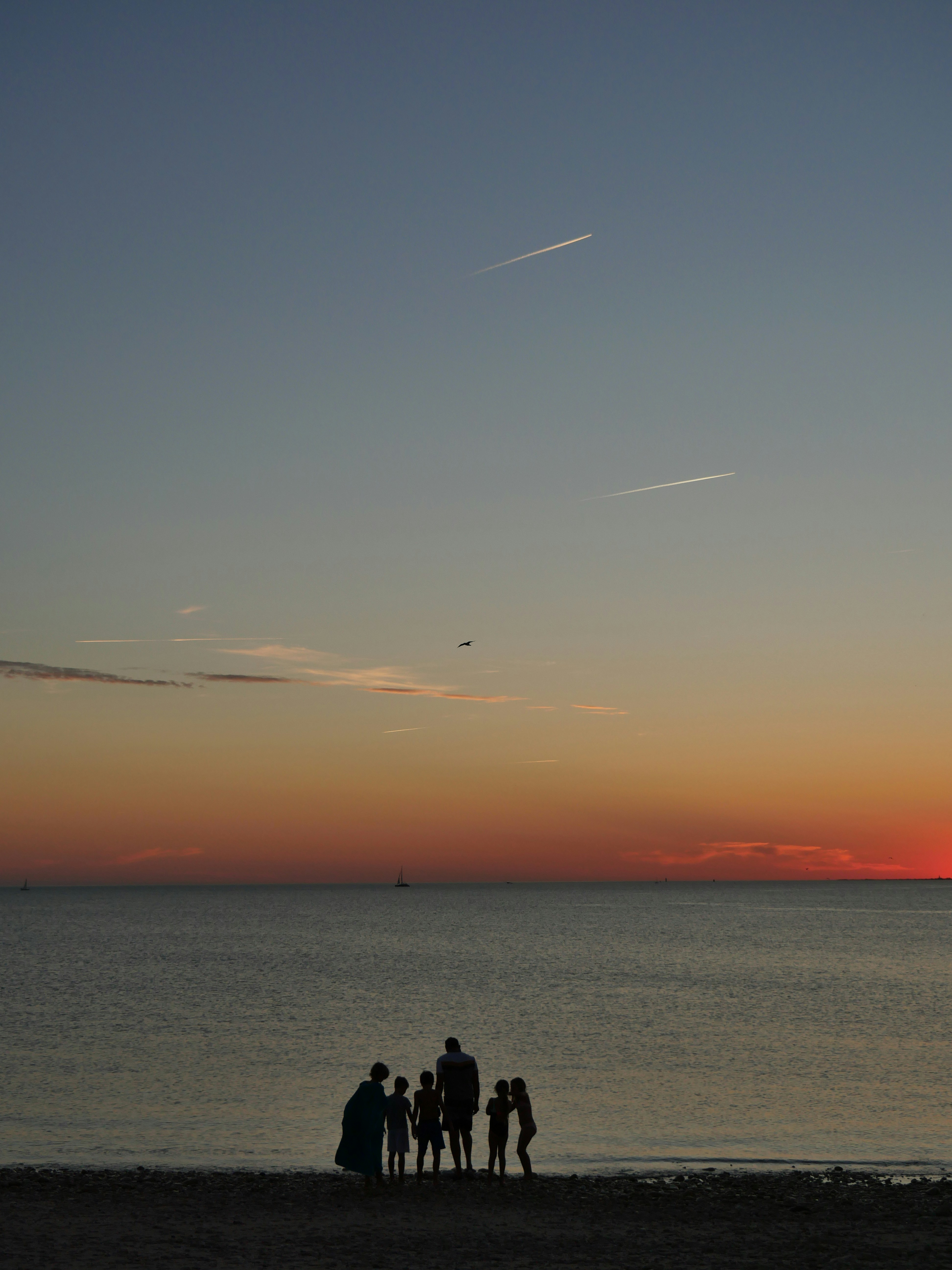 Dusk Circle on the Shoreline: A Silhouette Ensemble at Sunset