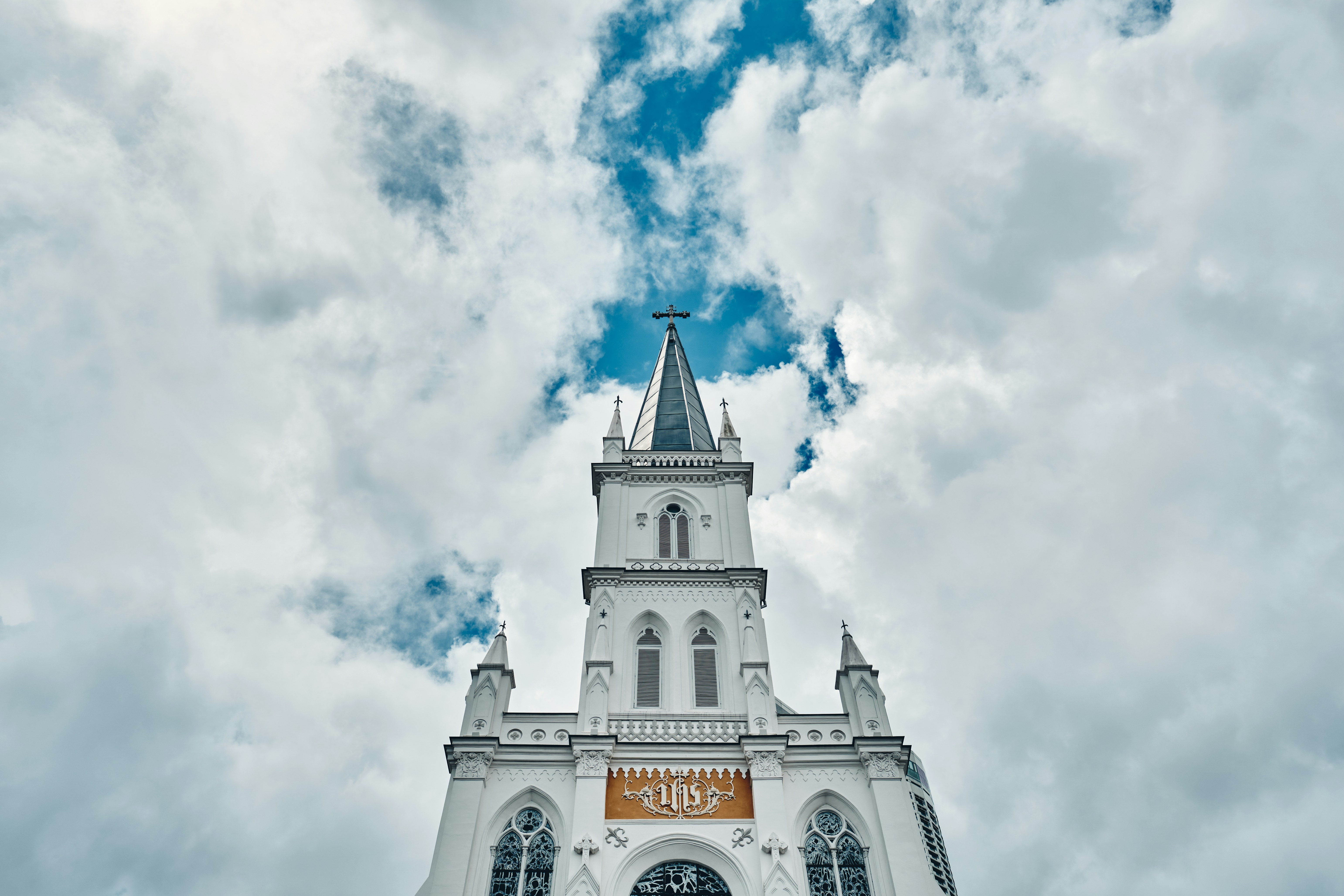 A large white church with a steeple and a cross on top photo – Free ...