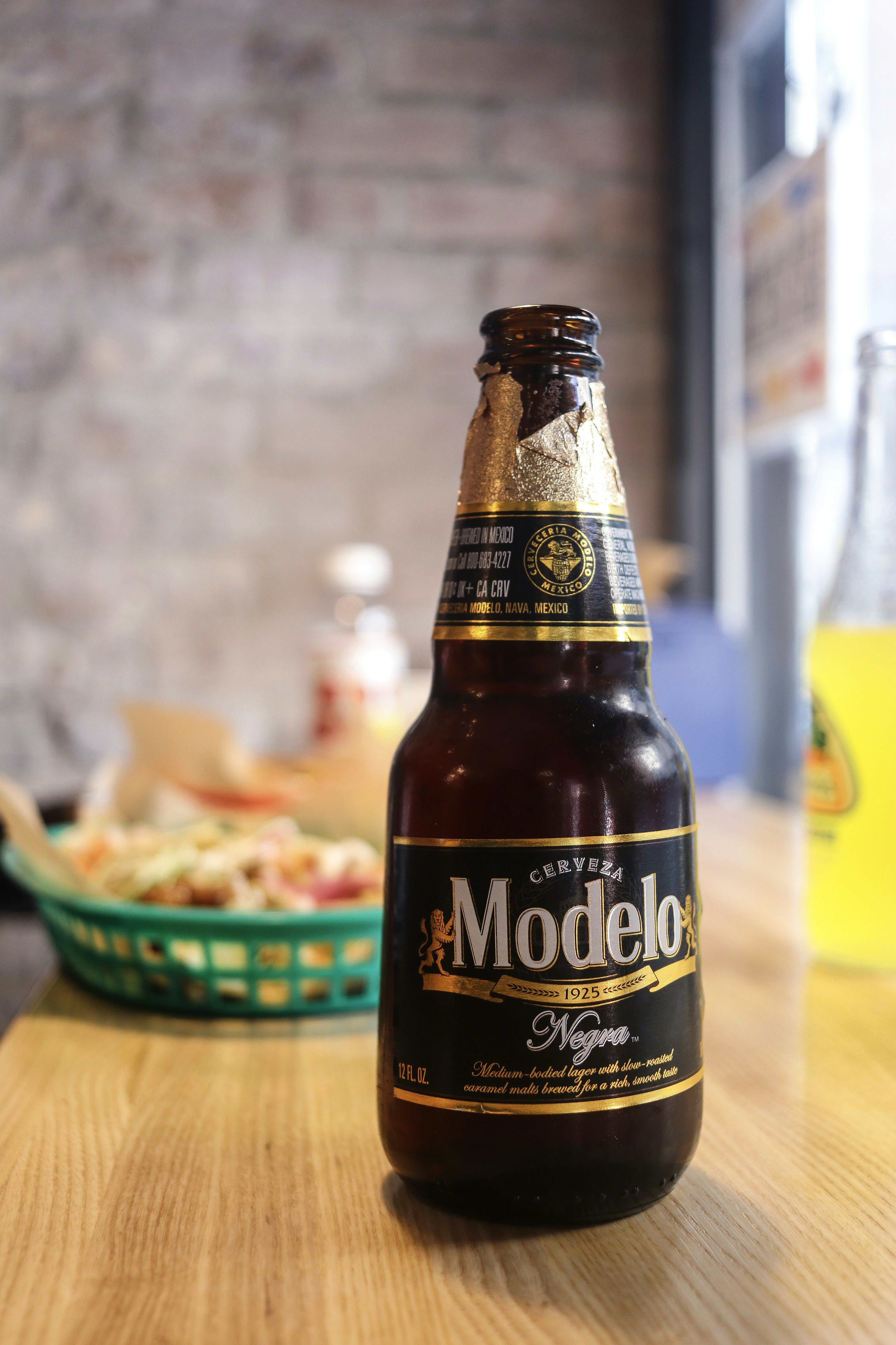 A bottle of modelo beer sitting on a table photo – Free Alcohol Image ...