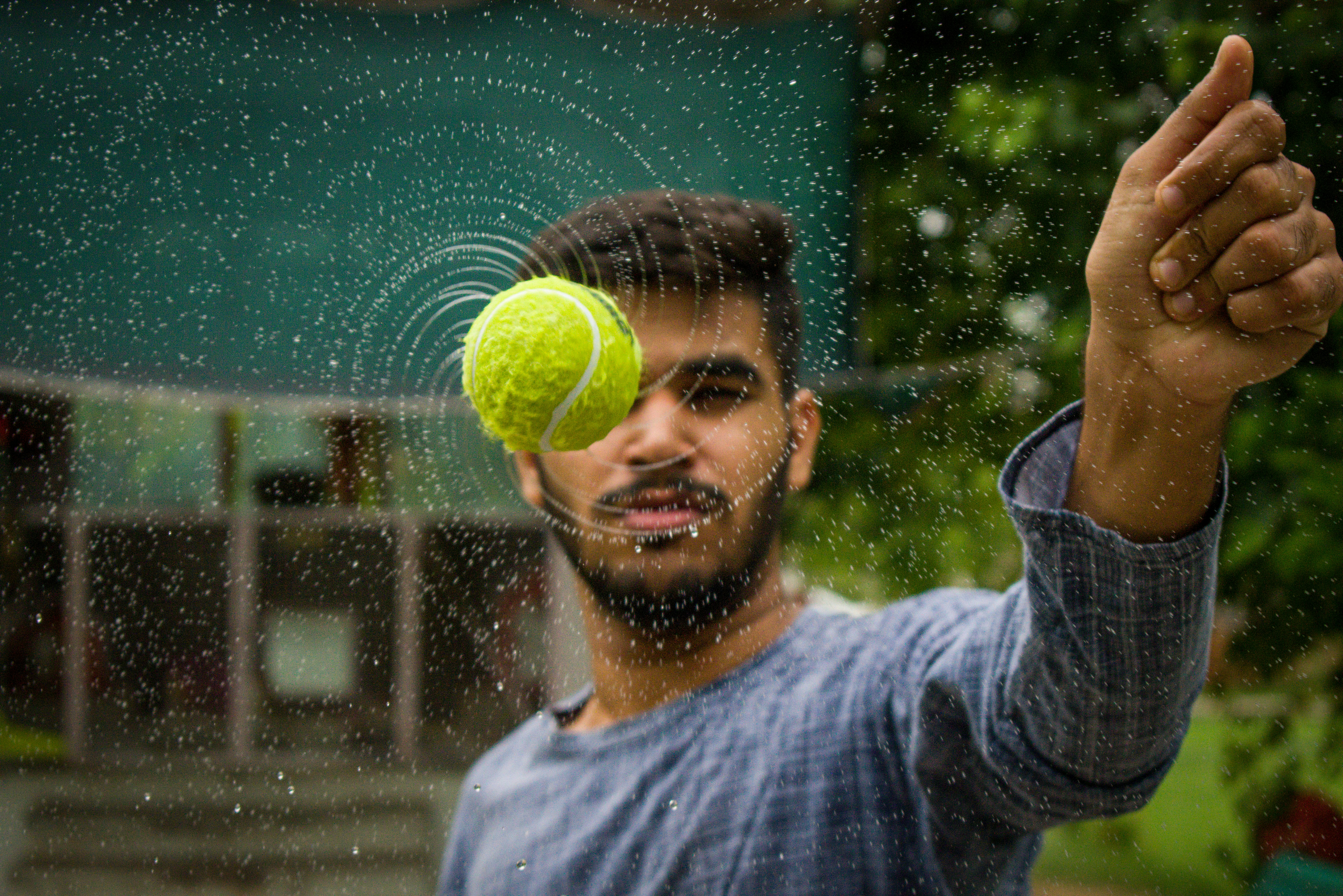 A man is throwing a tennis ball in the air photo – Free Experimental ...