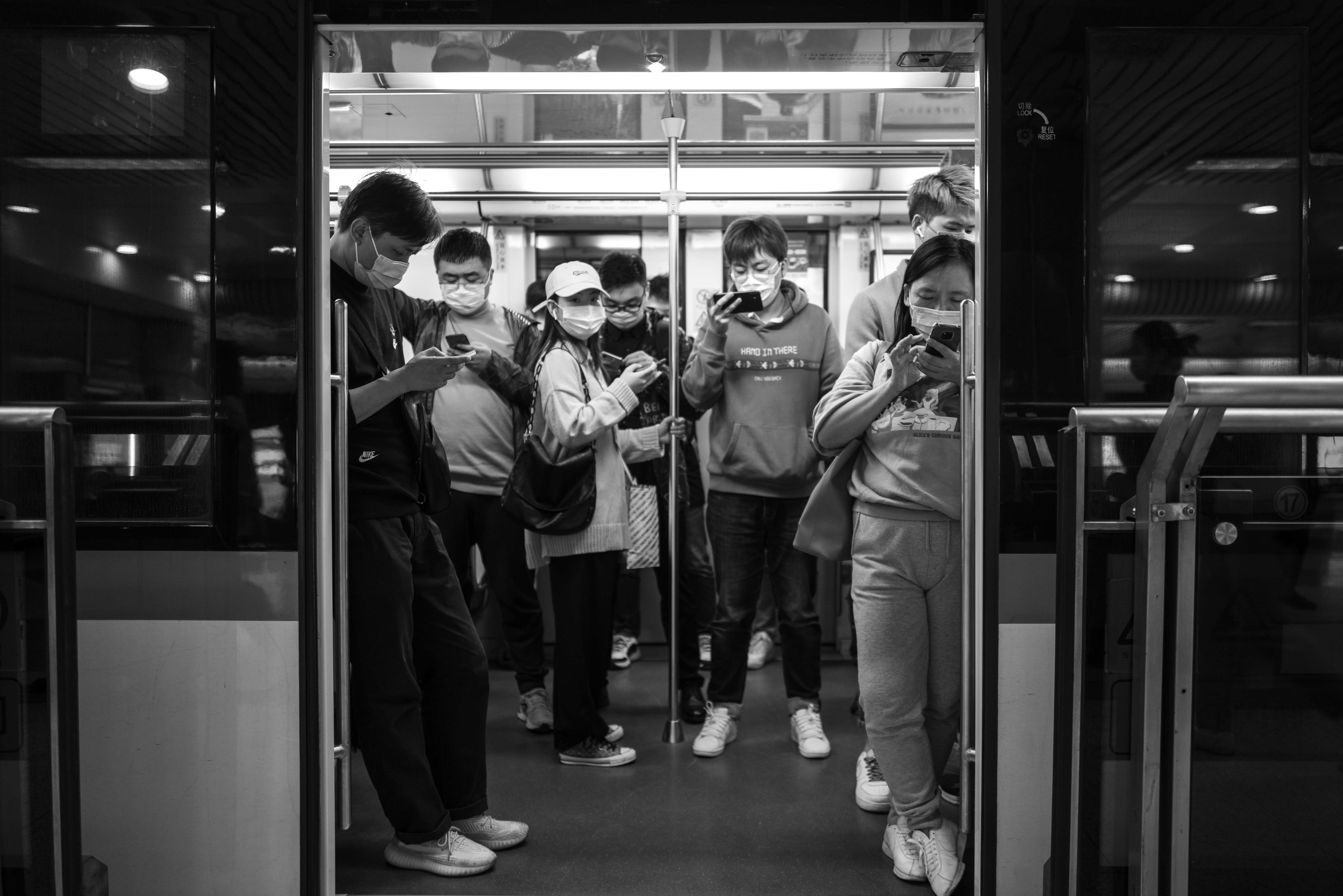 a group of people standing on a subway train
