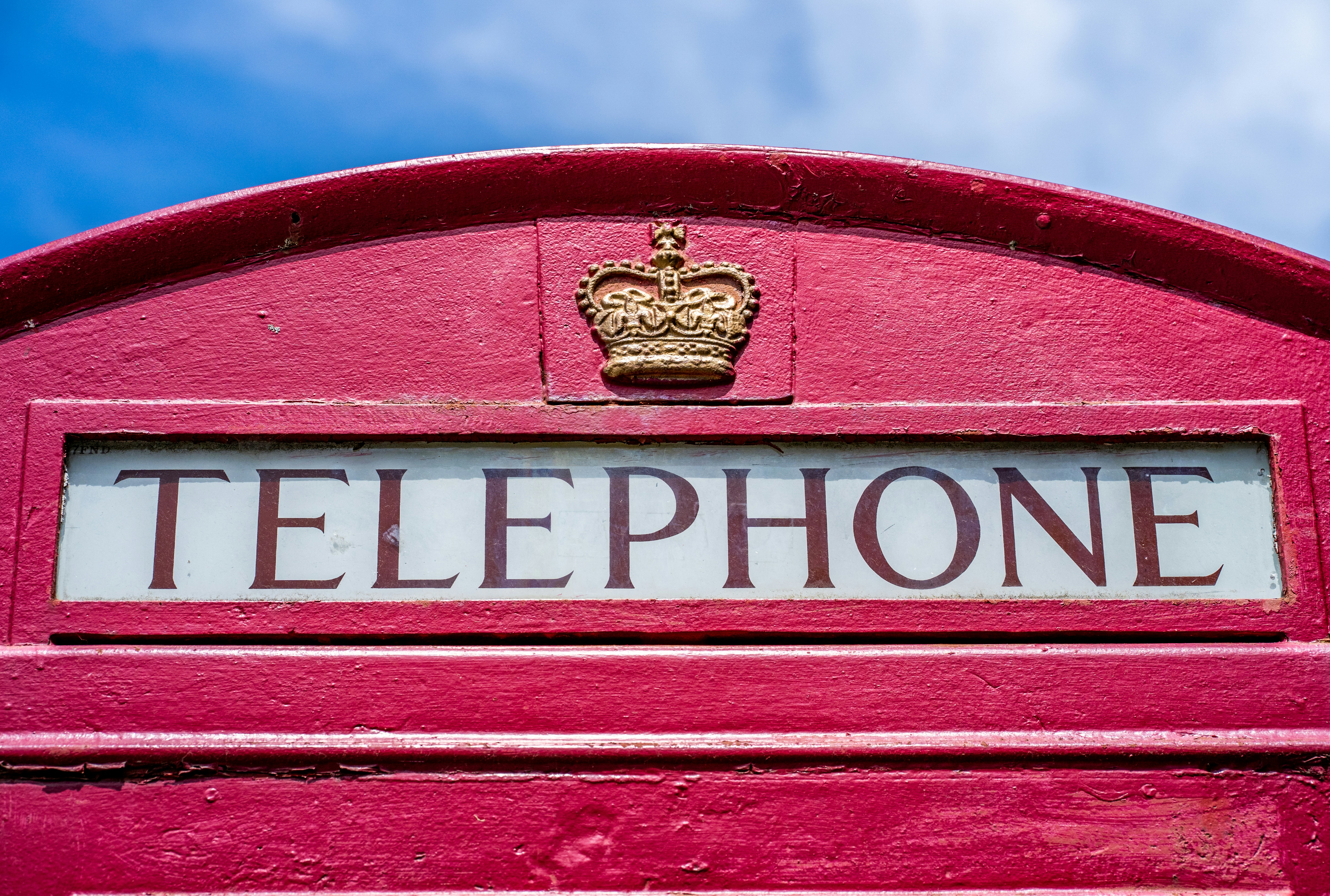 A red telephone booth with a crown on top photo – Free Telephone Image ...
