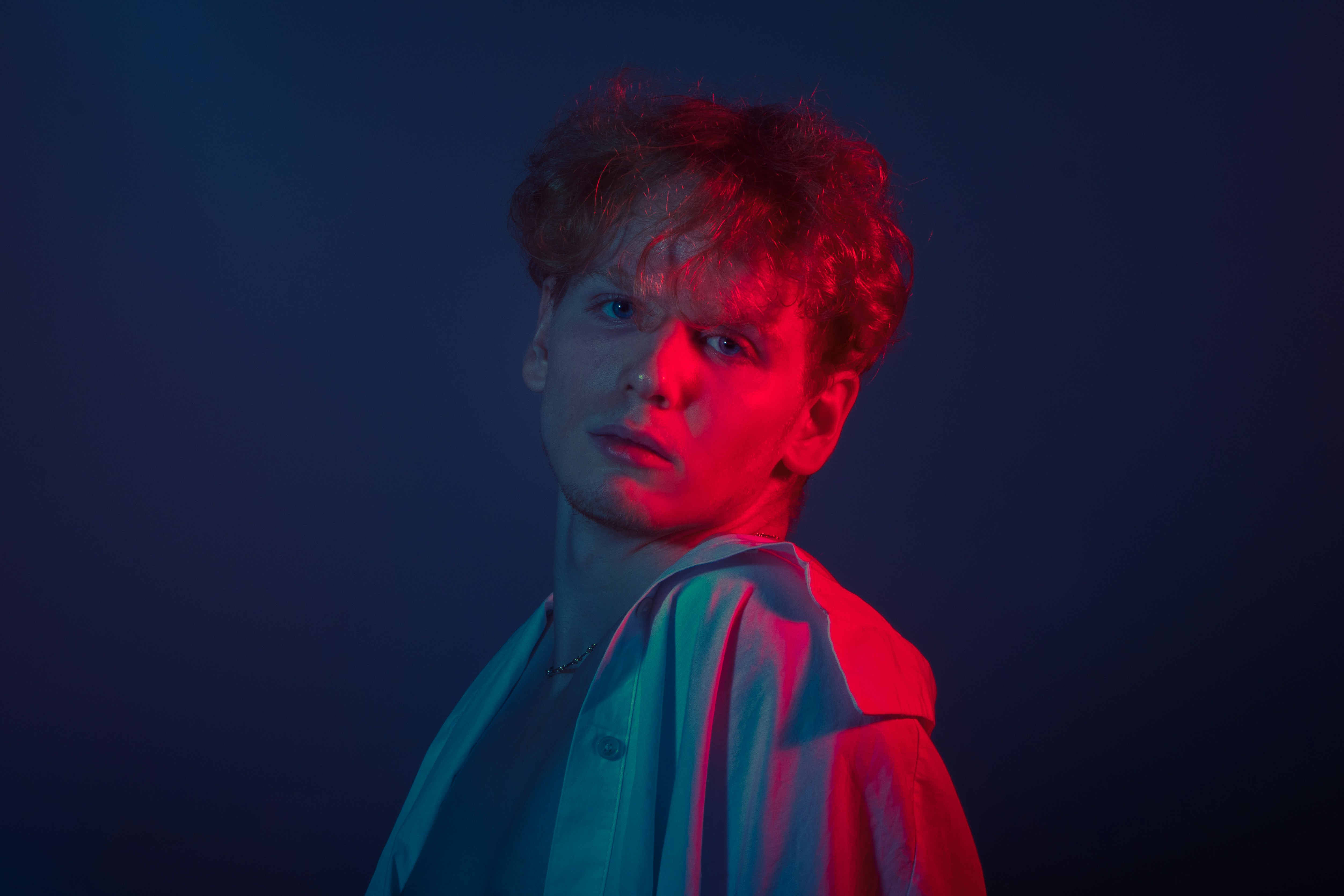 Crimson and Azure Gaze: A Studio Portrait in Dual Light