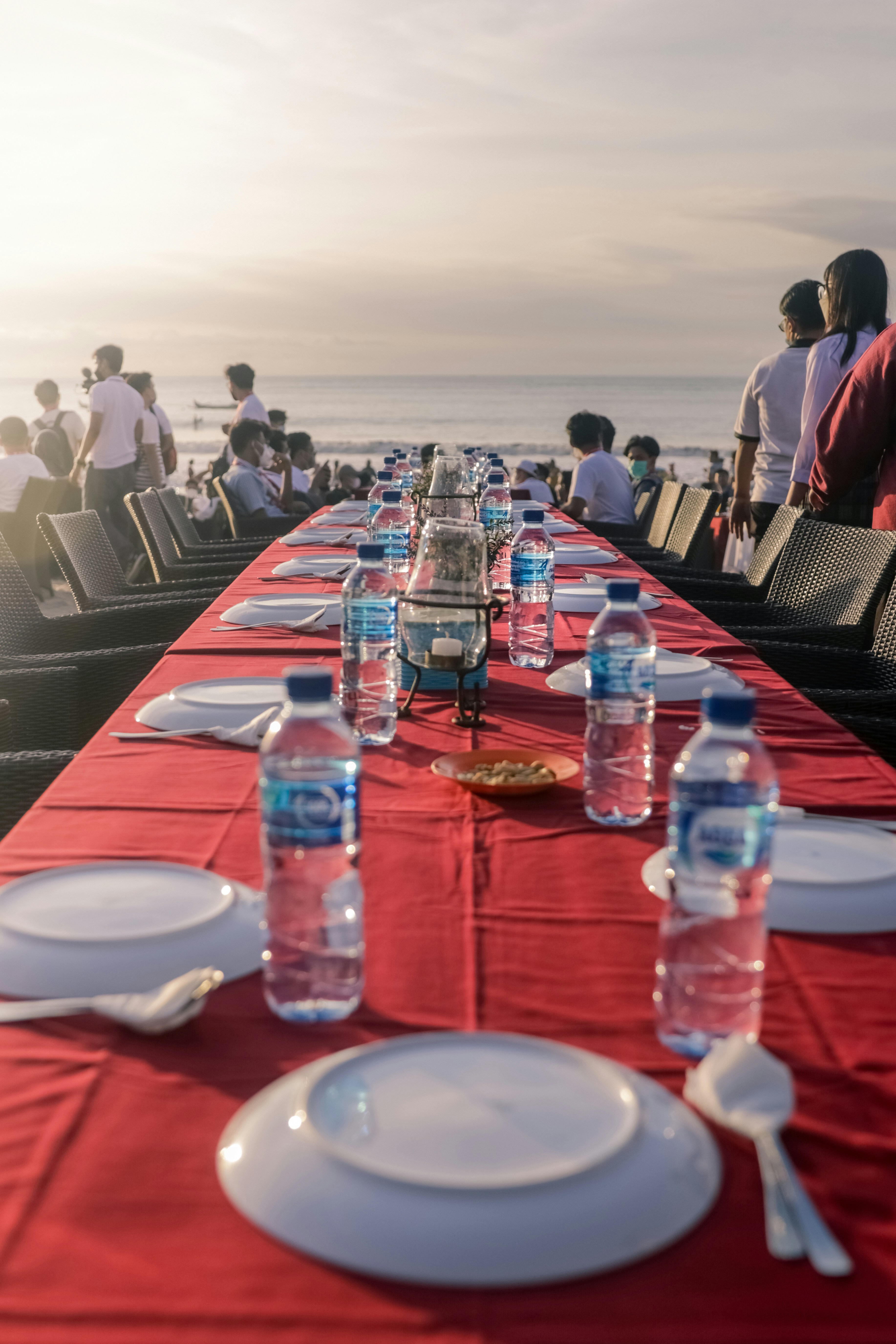 a long table with water bottles and plates on it