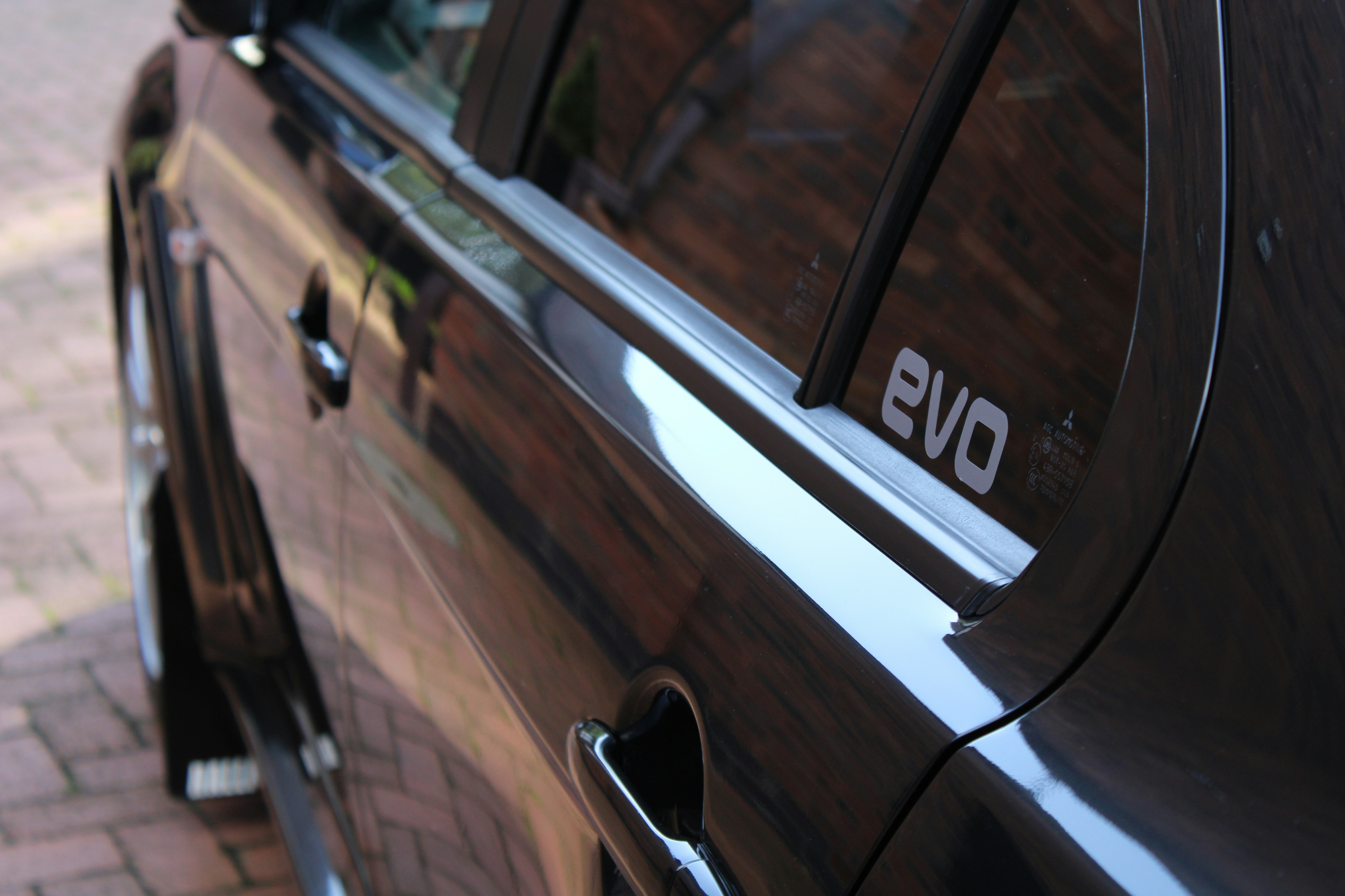 Reflective Noir: Chrome Lines on a Midnight Car Panel