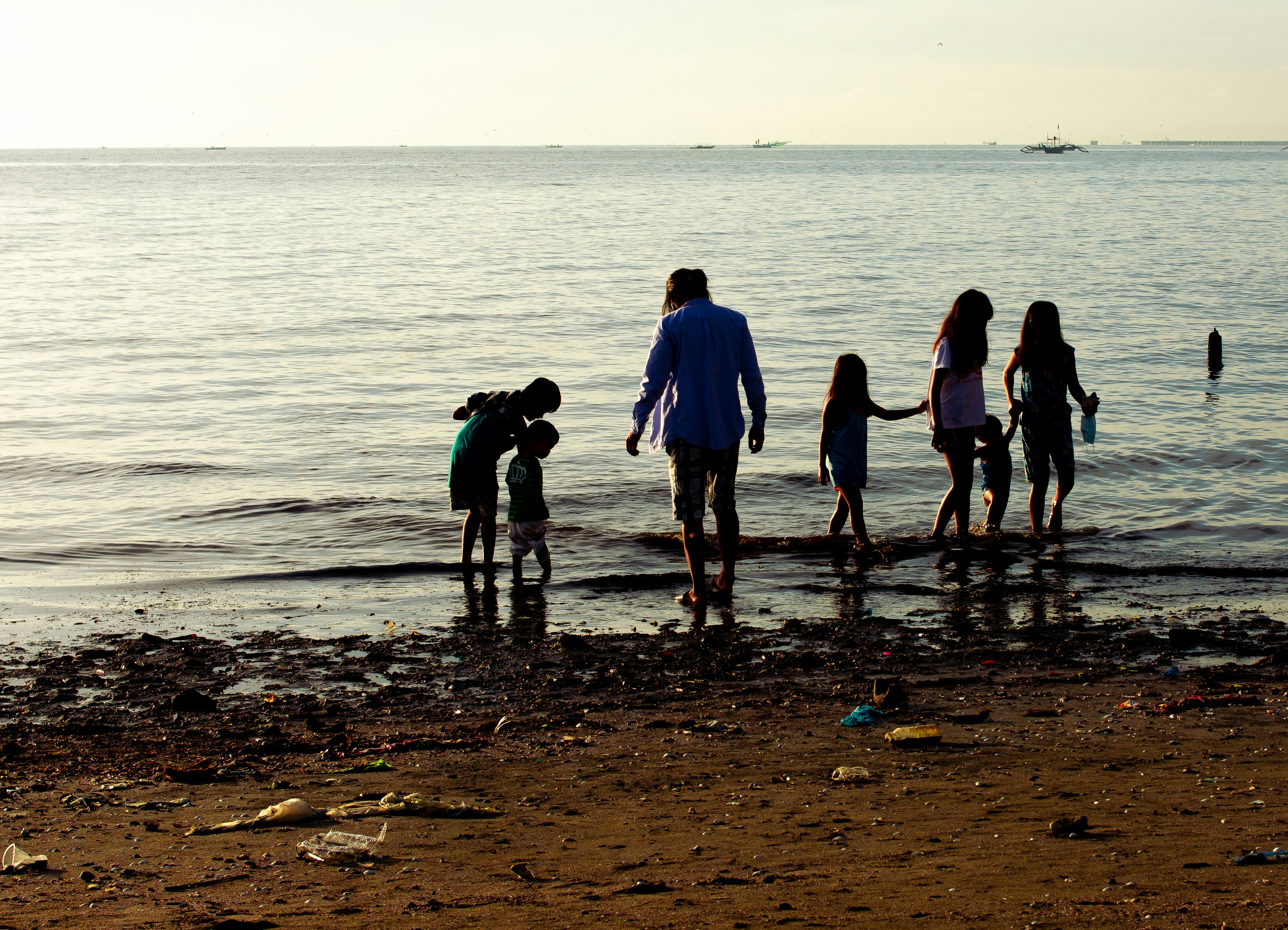 Family at the Shoreline: Feet in the Wet Sand, Hands Linked at Sunset
