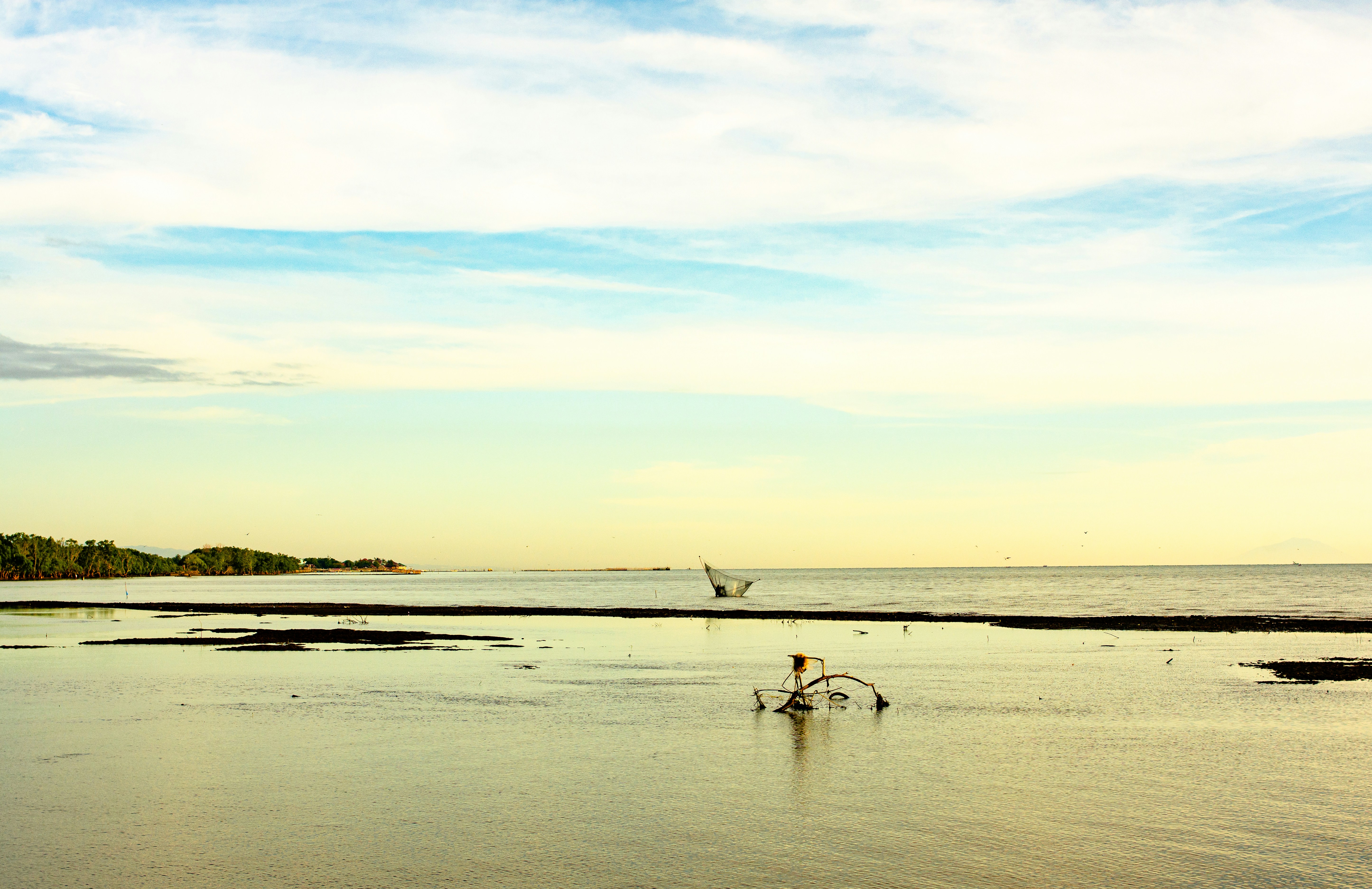 Quiet Tide: A Sailboat on a Reflective Horizon