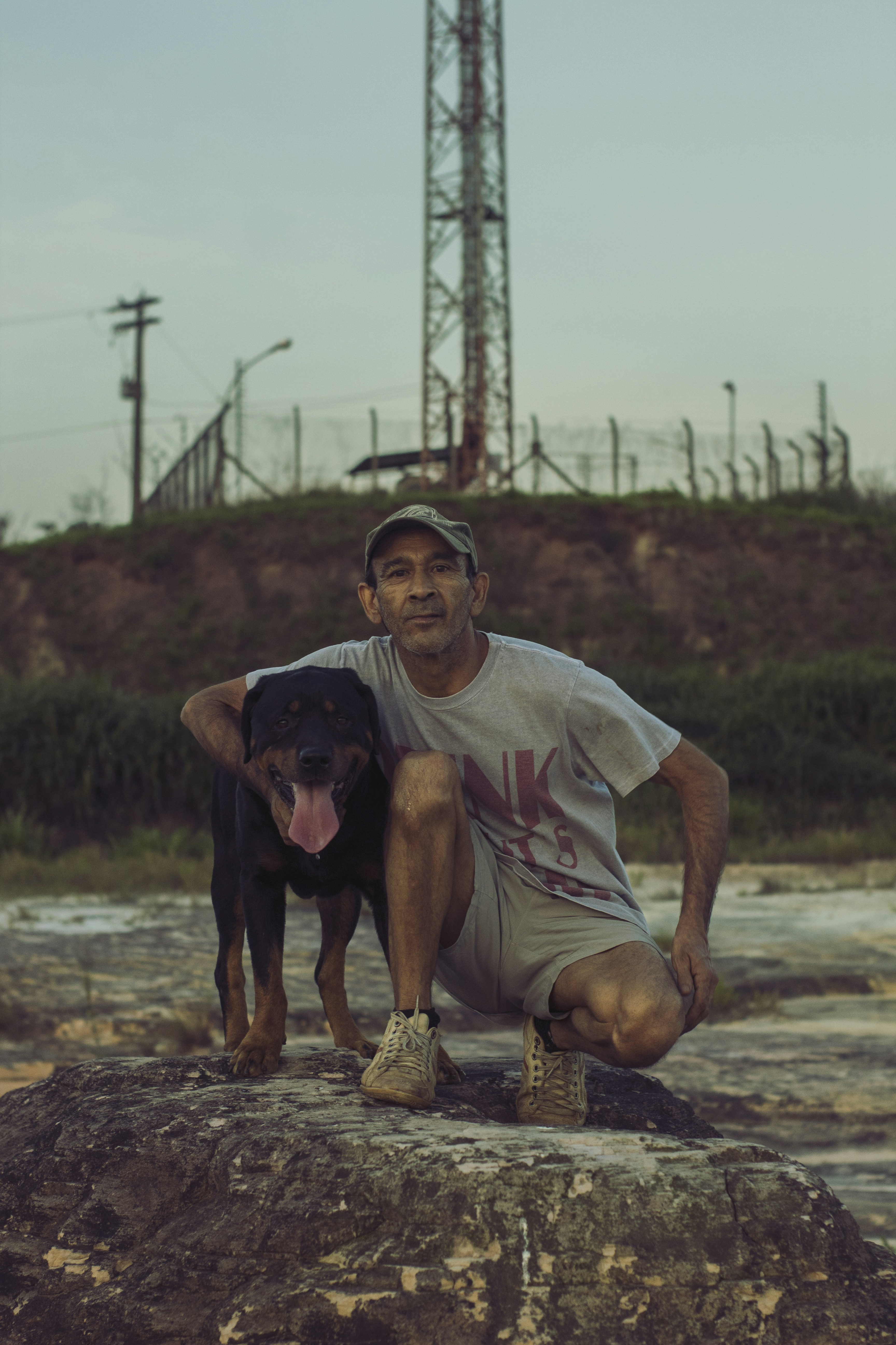 a man kneeling down next to a dog