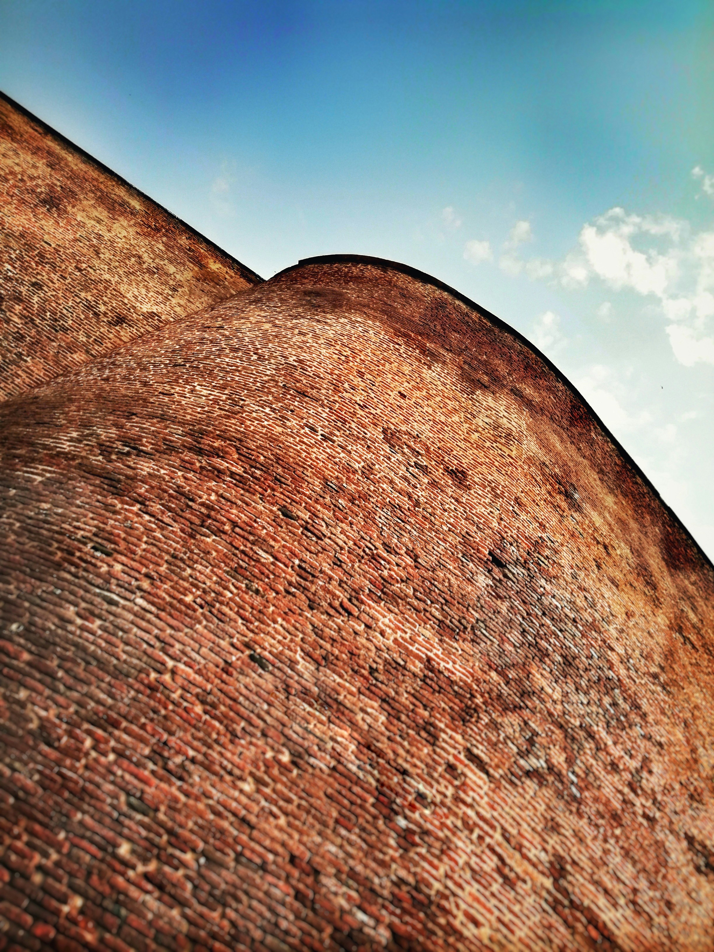 Curved Brick Monolith Against a Wide Sky