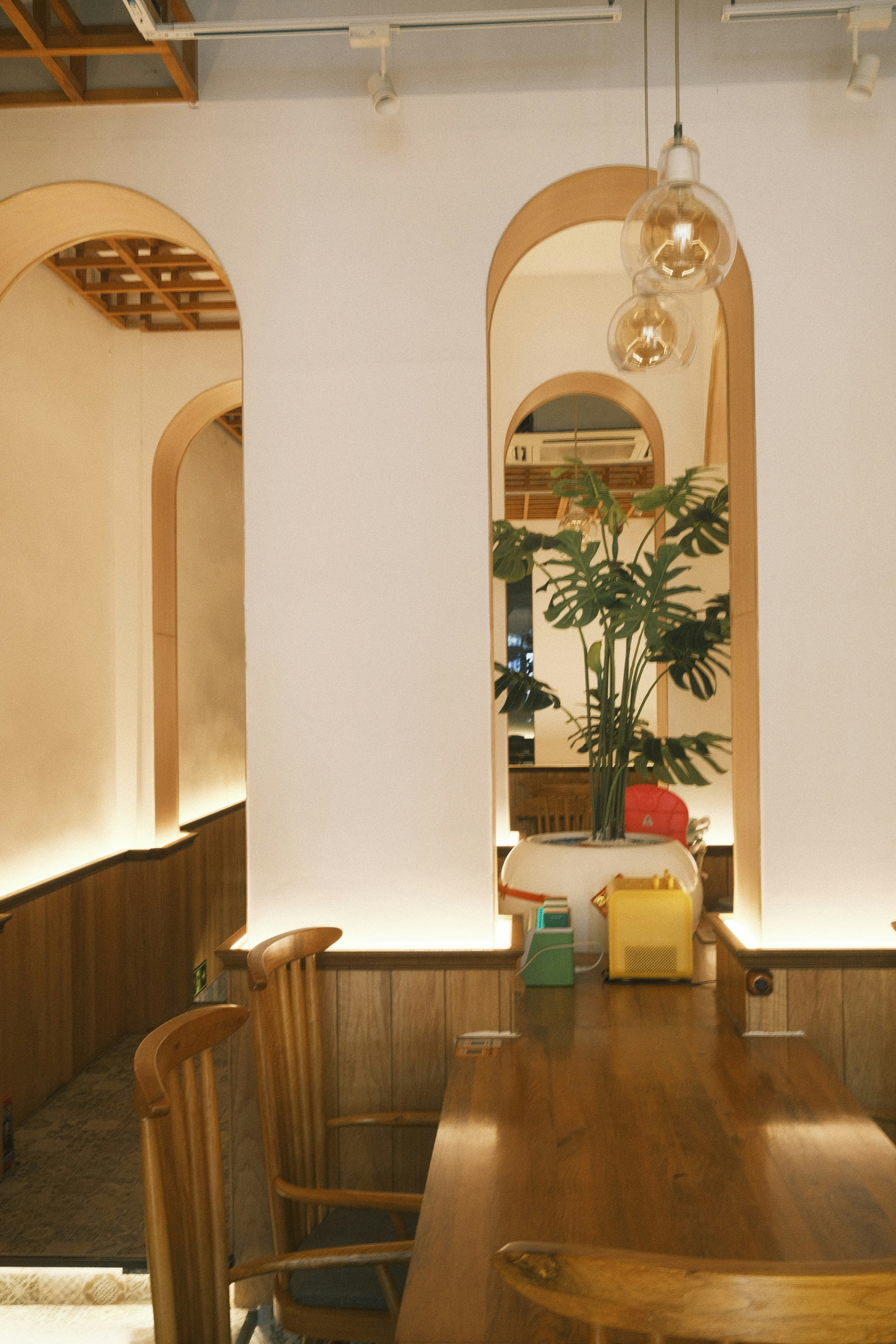 a dining room with a wooden table and chairs