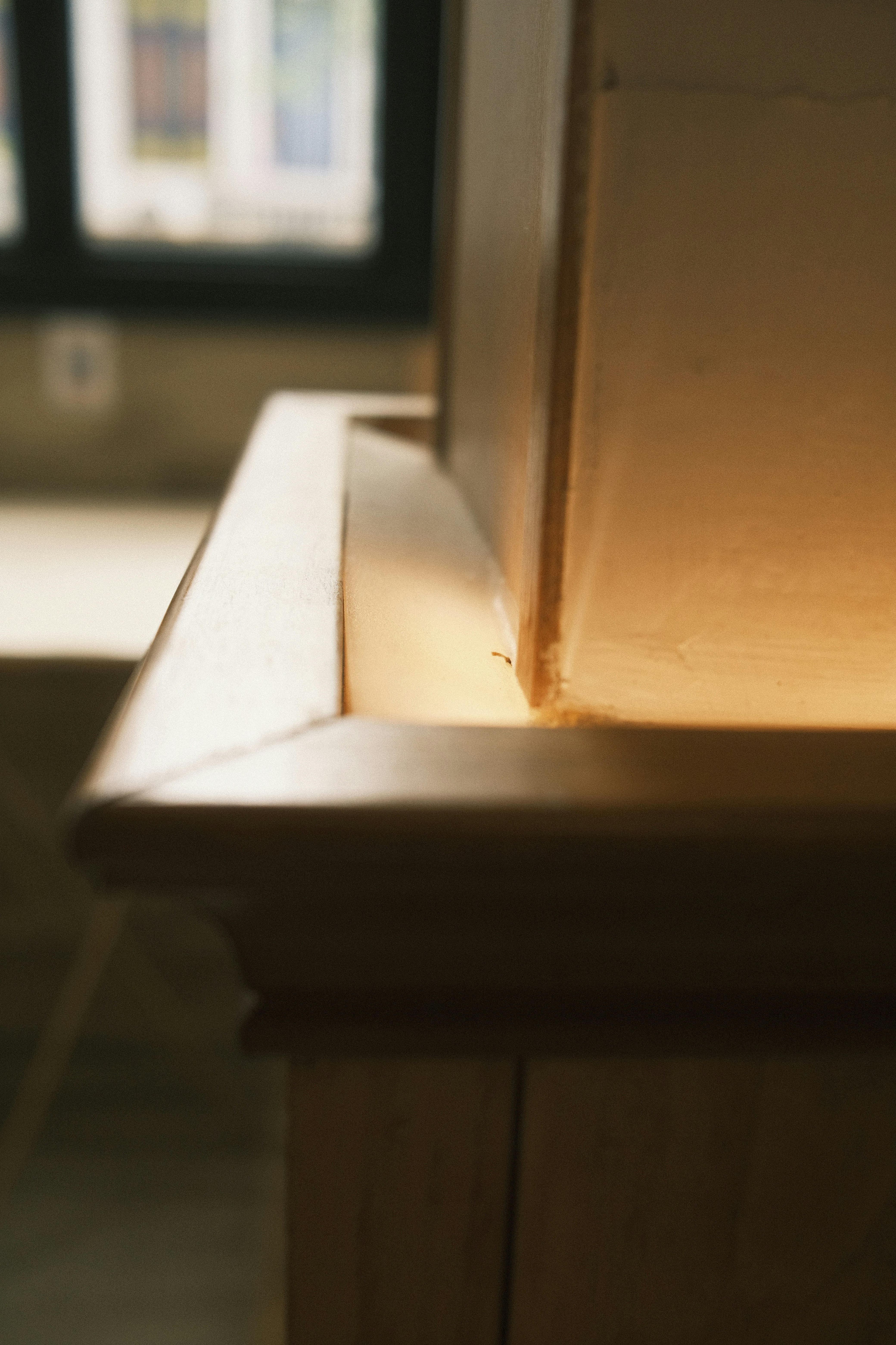 a close up of a window sill with a window in the background