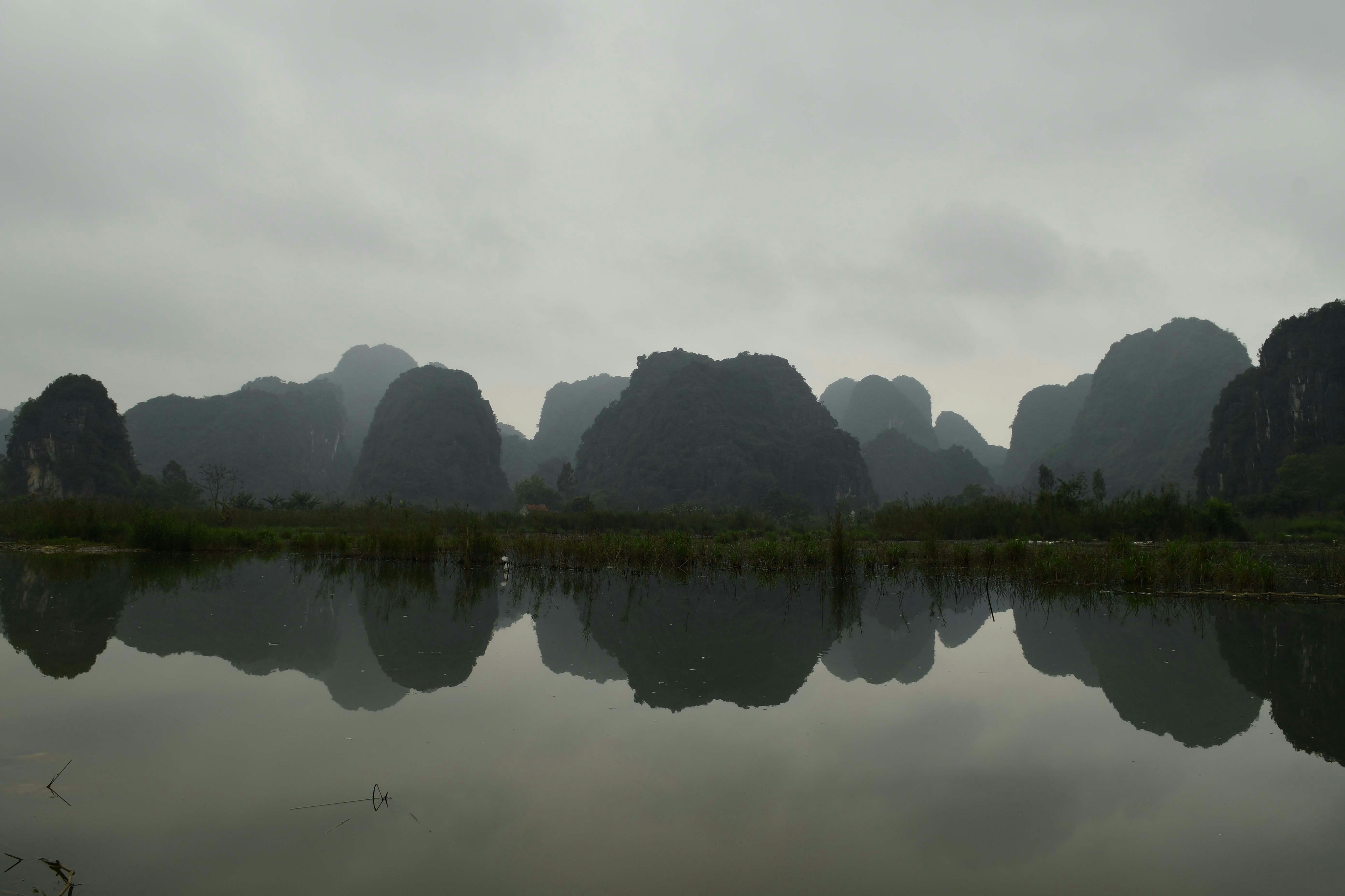 Echoes on the River: Karst Peaks in Quiet Reflection