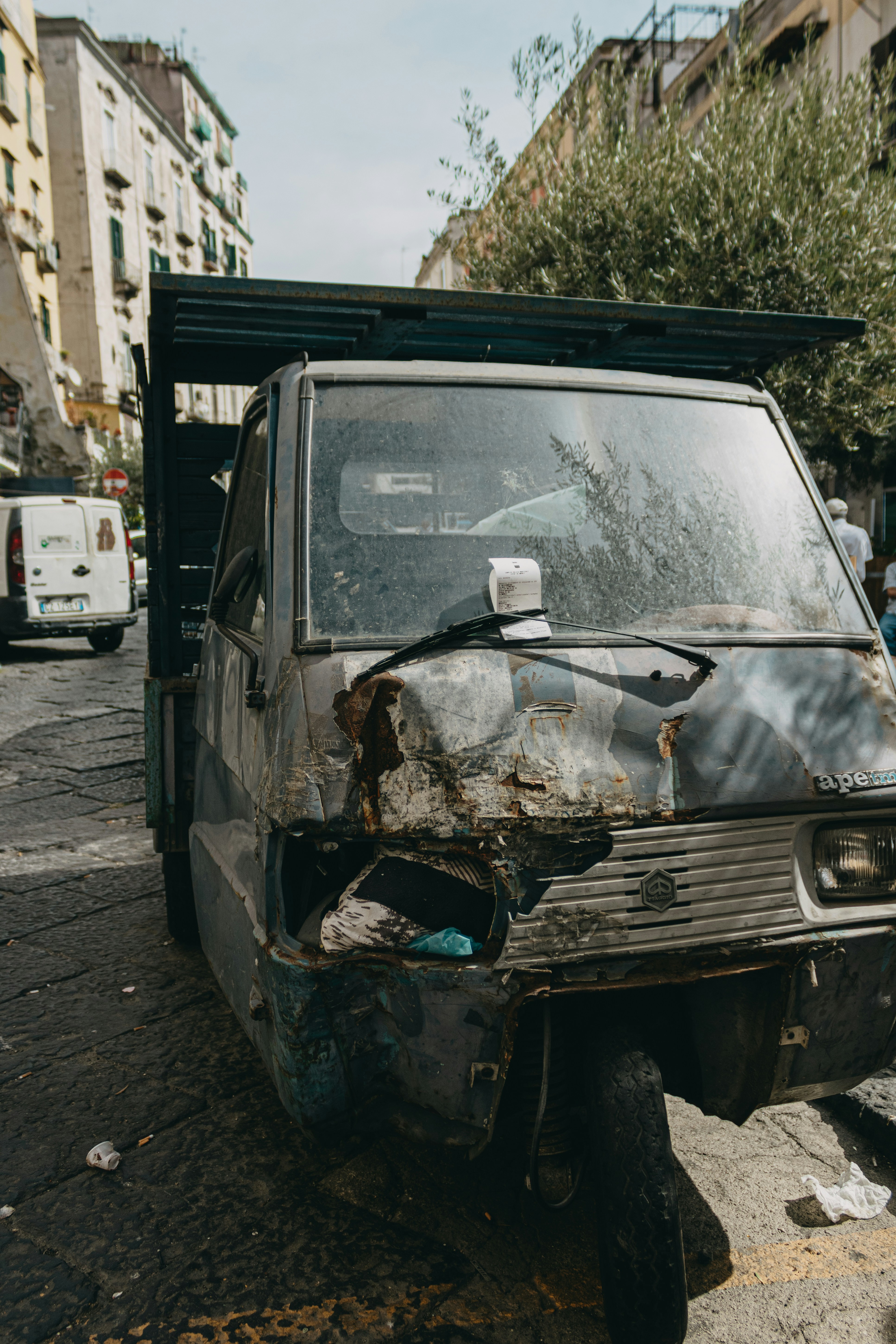 Rust, Rubble, and Rims: A Weathered Cargo Van Under City Light