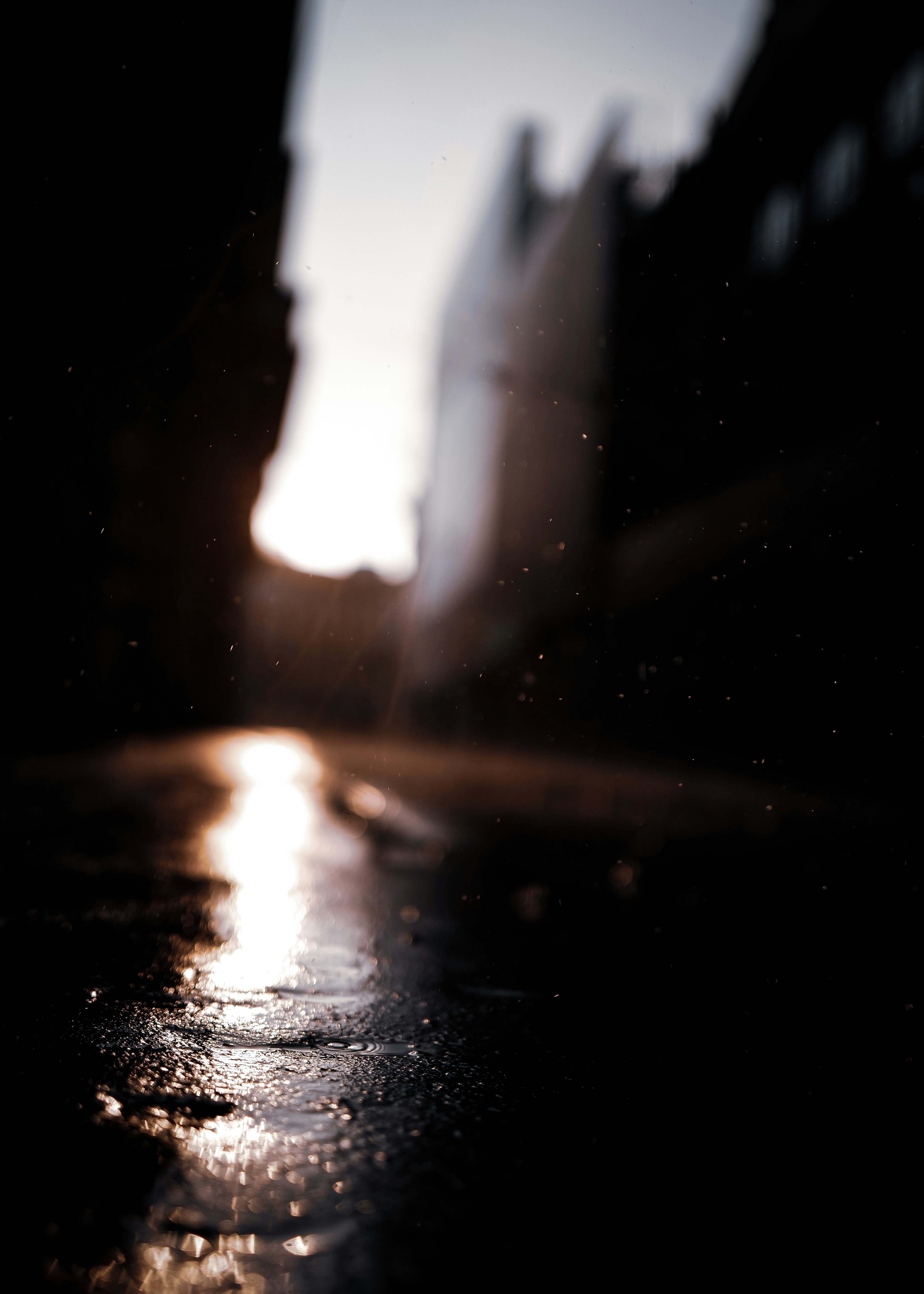 End of the Alley: Warm Glow Beyond the Rain-Slick Street