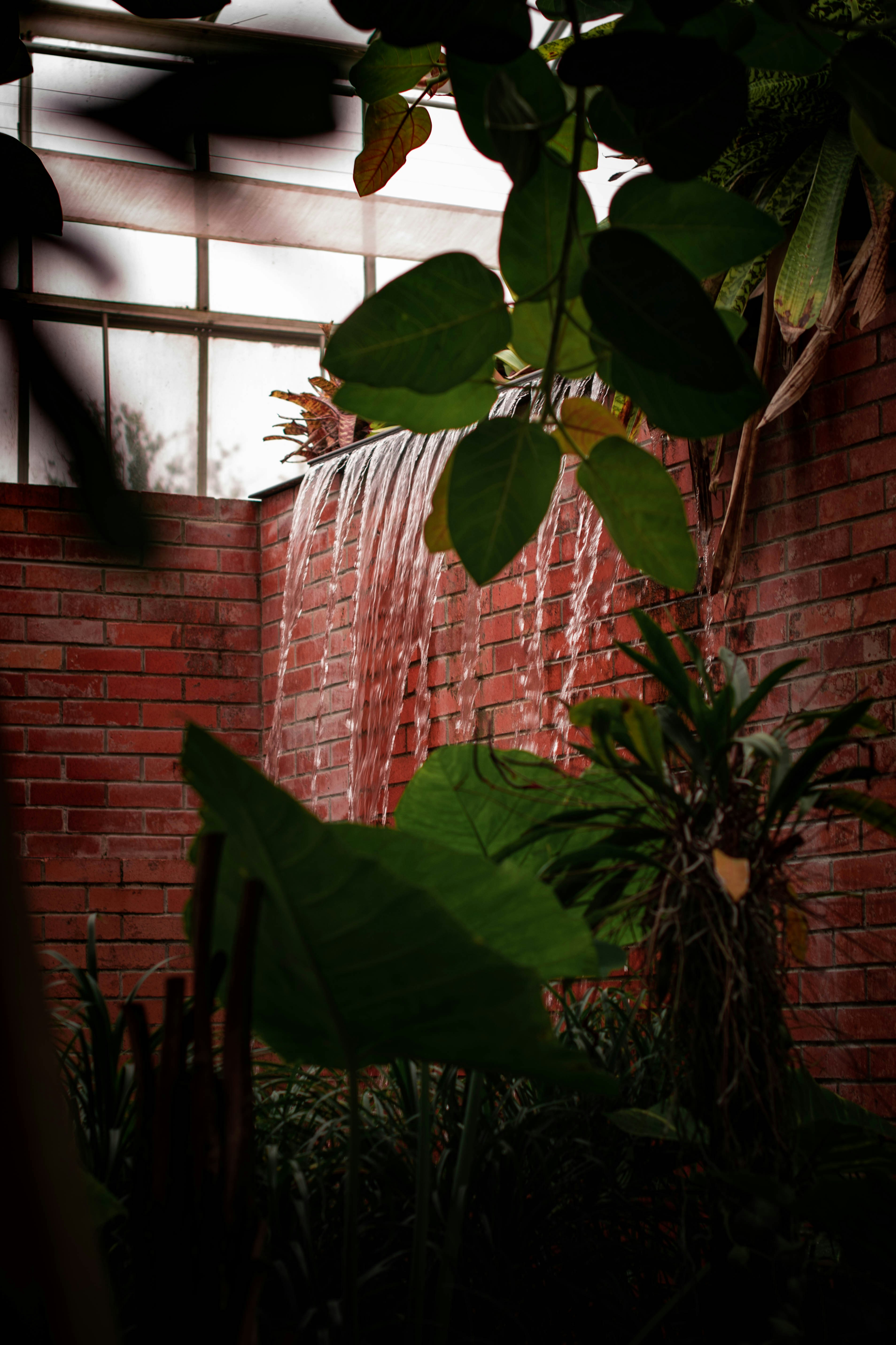 a red brick building with a waterfall coming out of it