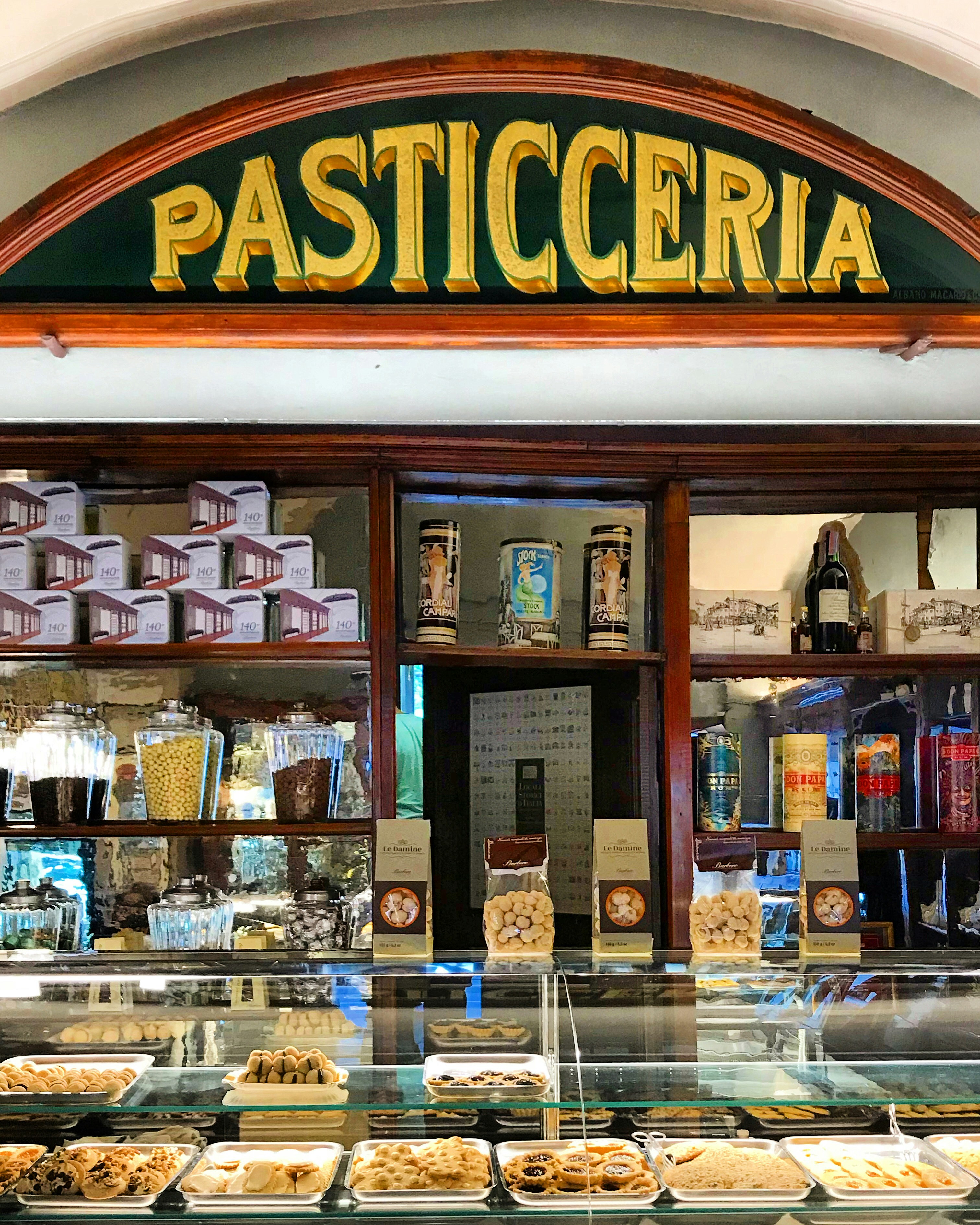 A pastry shop with a display of pastries photo – Free Shop Image on ...